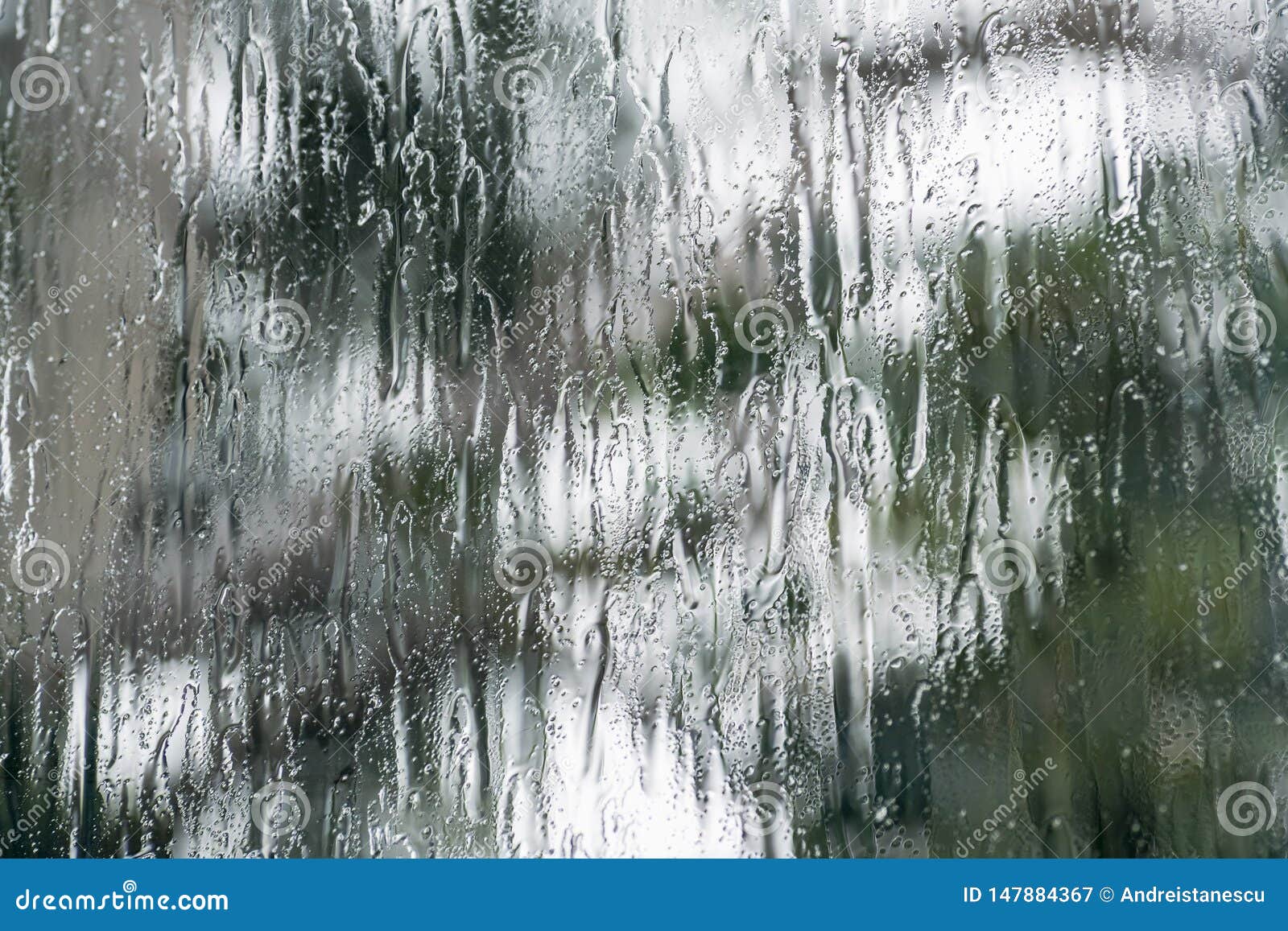 Pouring Rain Covering the Window during a Storm; Blurred Tree Shape ...