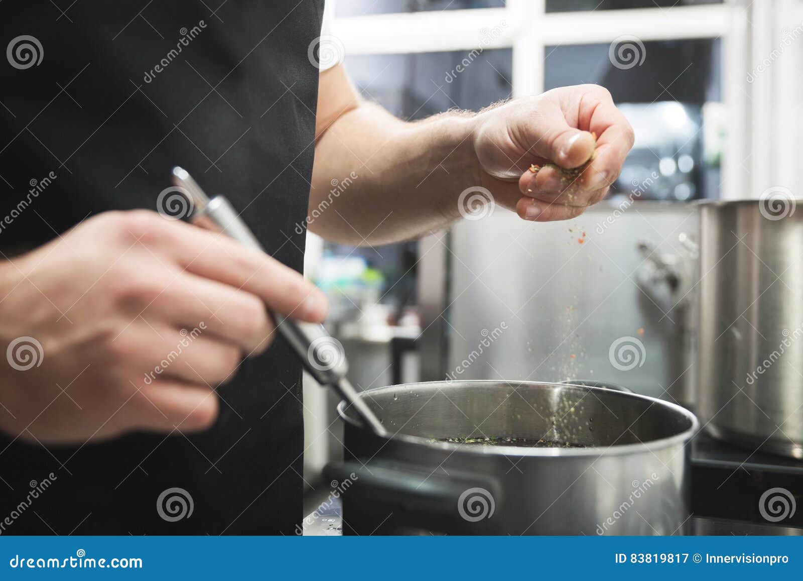 Pouring spices to the soup stock image. Image of male - 83819817