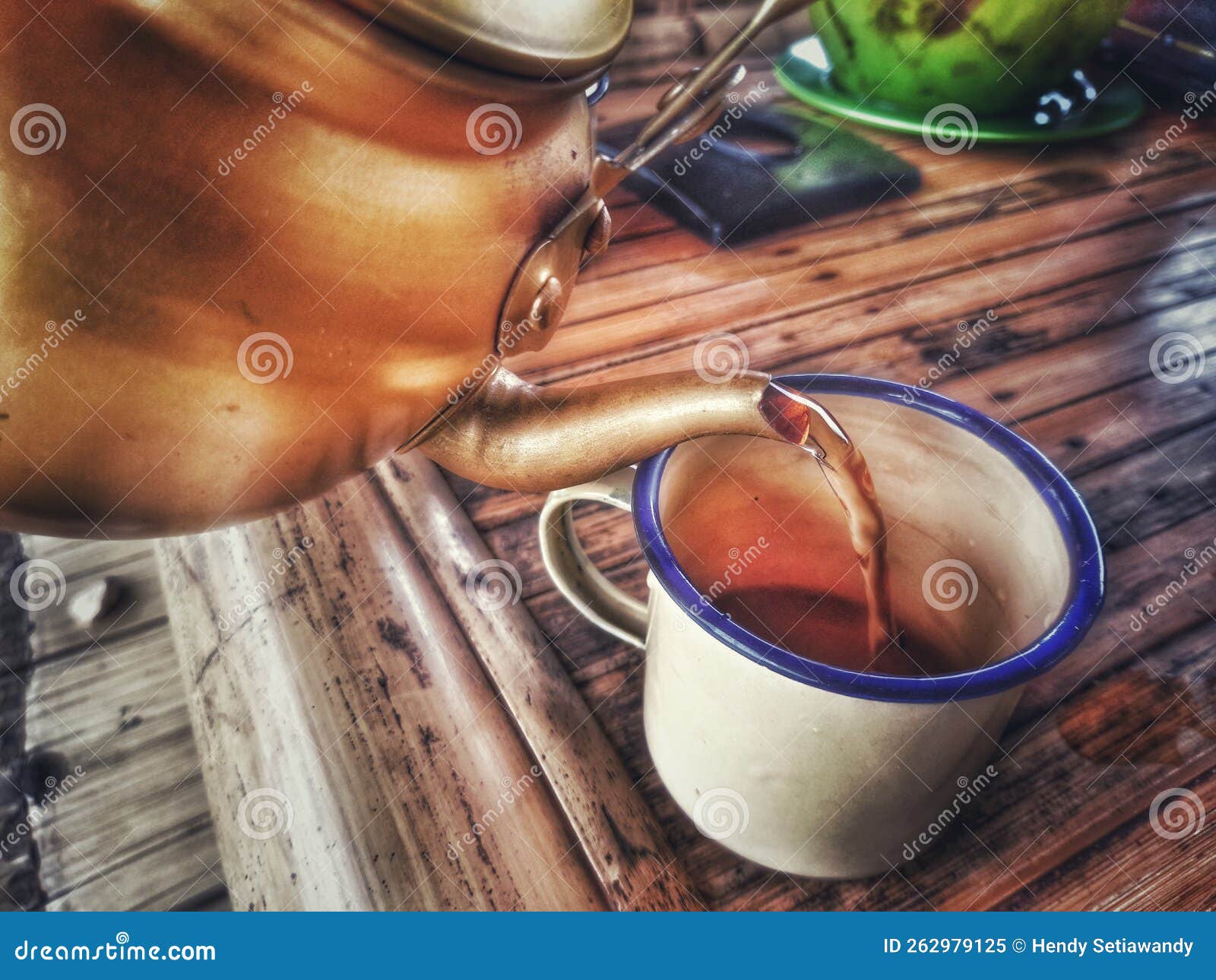 Pouring tea into a cup stock image. Image of pouring - 262979125