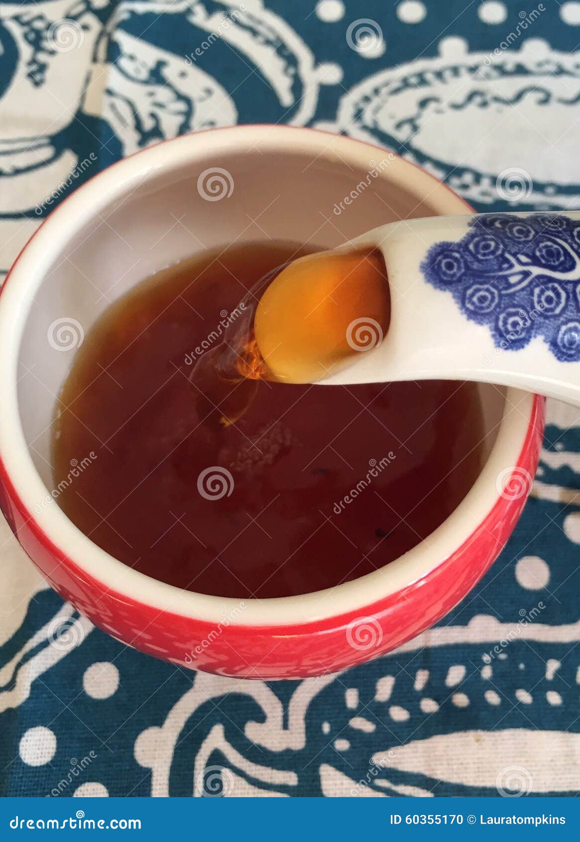 Pouring tea into a Red Cup stock photo. Image of cheerful - 60355170