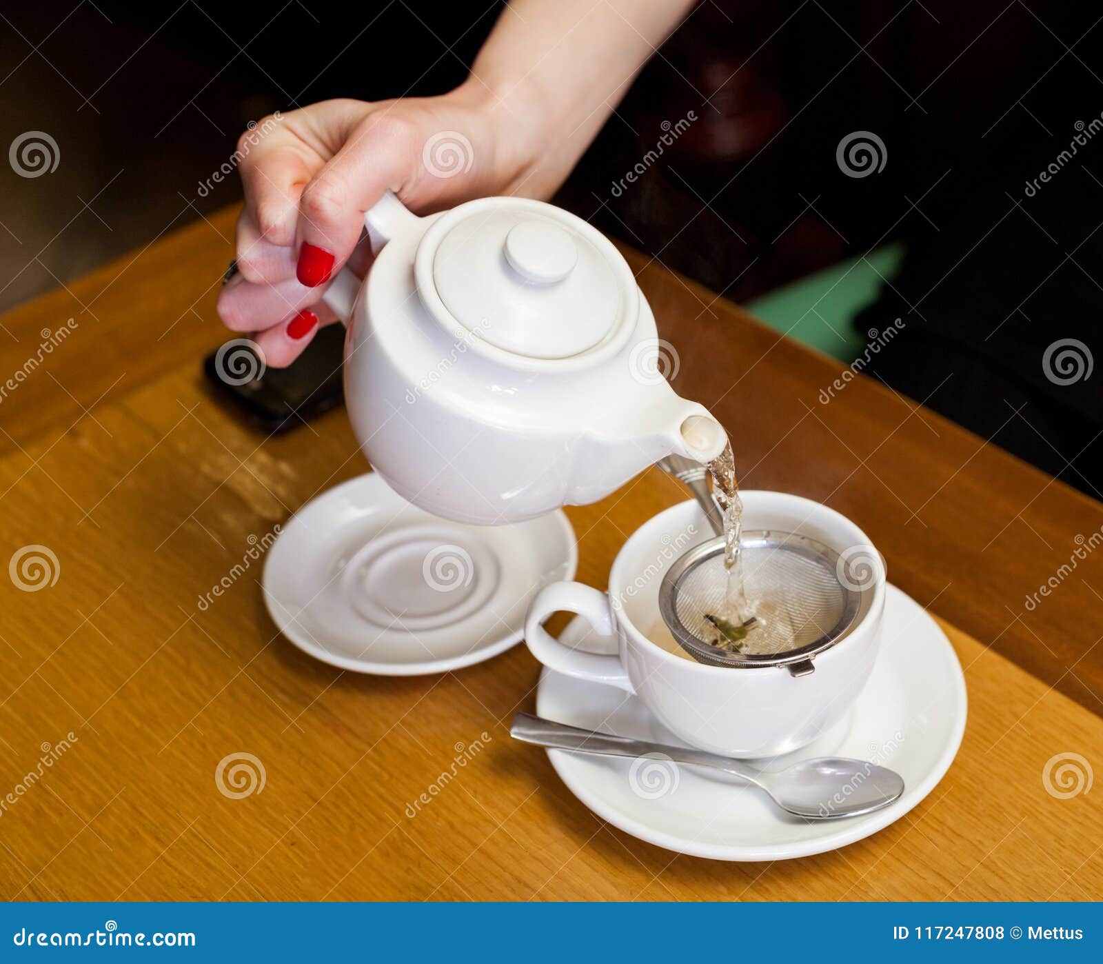 Pouring tea on table stock photo. Image of leaves, breakfast - 117247808