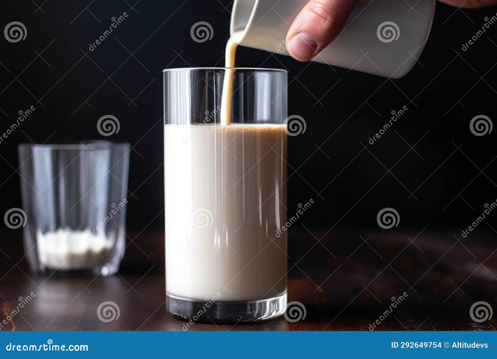 Pouring a Thick, Frothy Vanilla Shake into a Tall, Clear Glass Stock ...