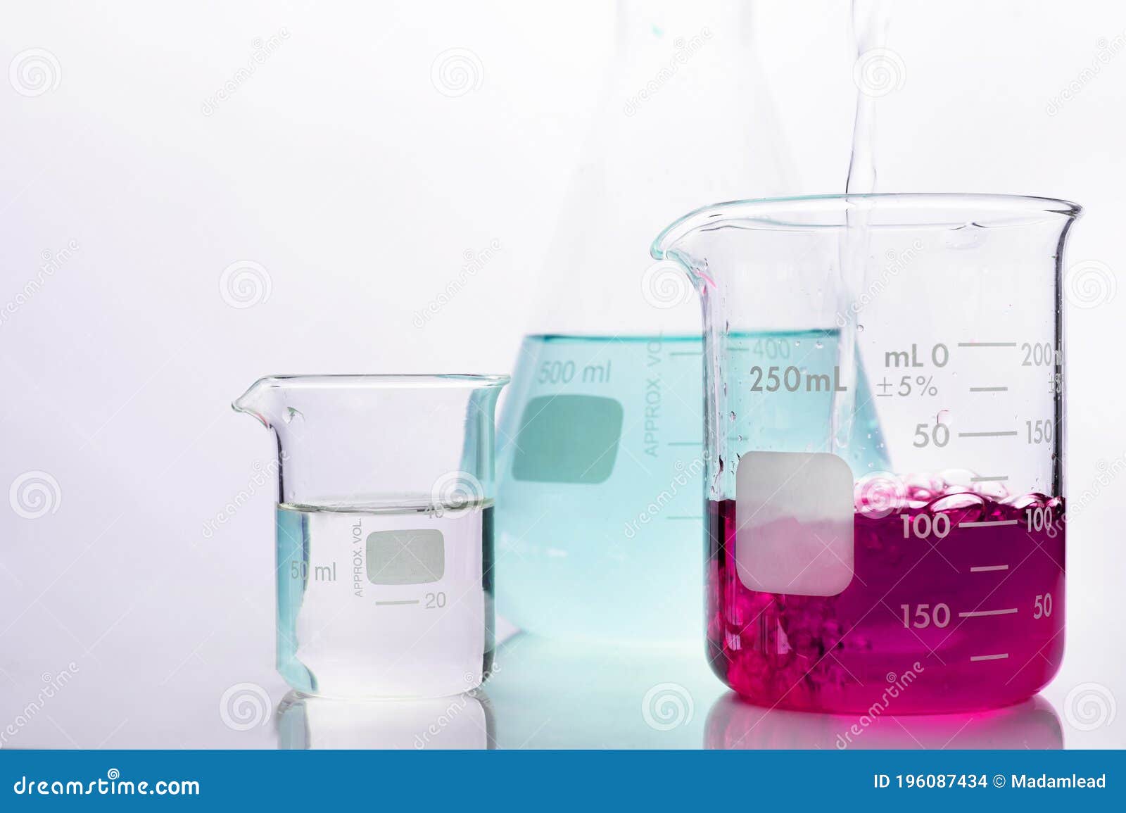 Pouring Water In Beaker With Pink Chemical Solution In White Science ...