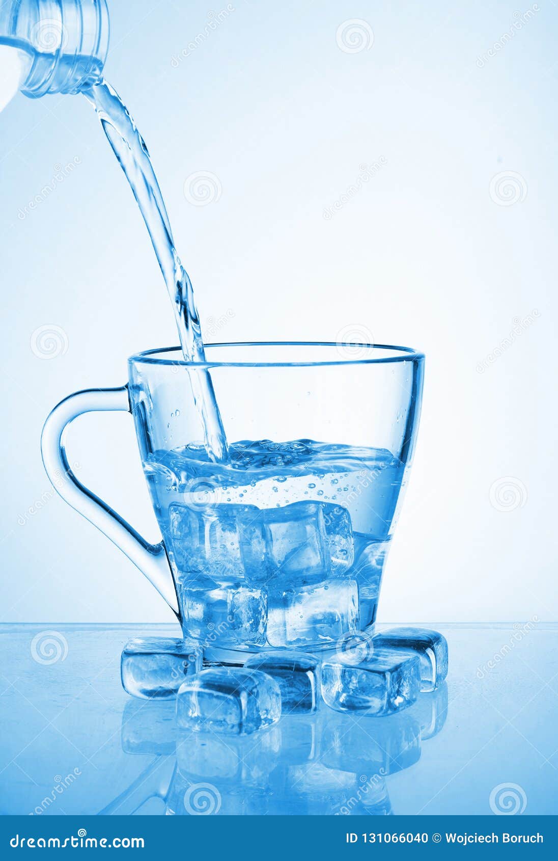 Pouring water into a cup stock photo. Image of drink - 131066040