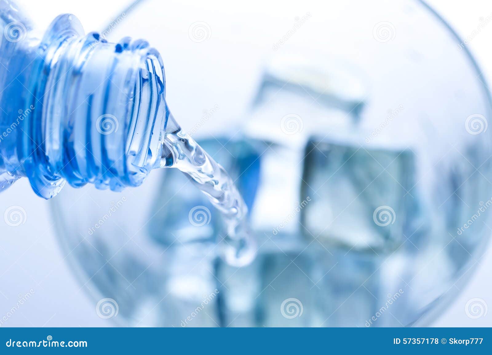 Pouring Water in an Elegant Glass with Ice and Water Drops. Stock Photo ...