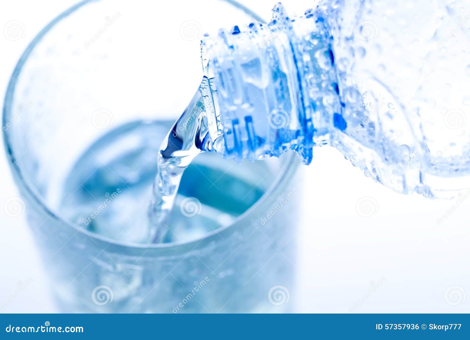 Pouring Water in an Elegant Glass with Ice and Water Drops. Stock Photo ...