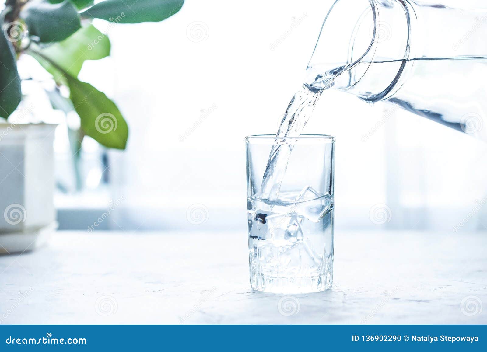 Pouring Water on Glass on White Table Stock Photo - Image of refreshing ...