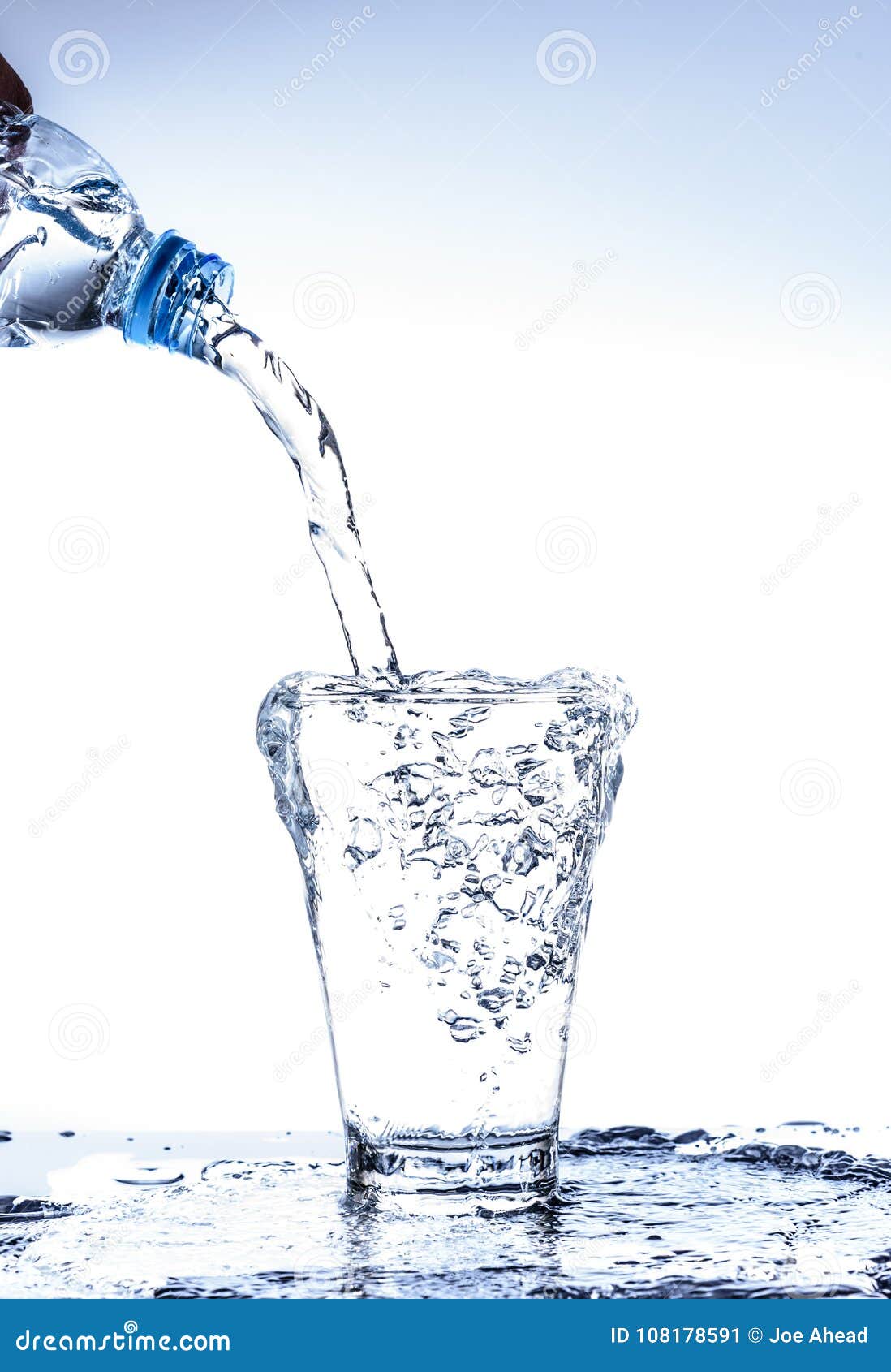 Pouring Water and Splashing in the Glass with Reflection on Mirror ...