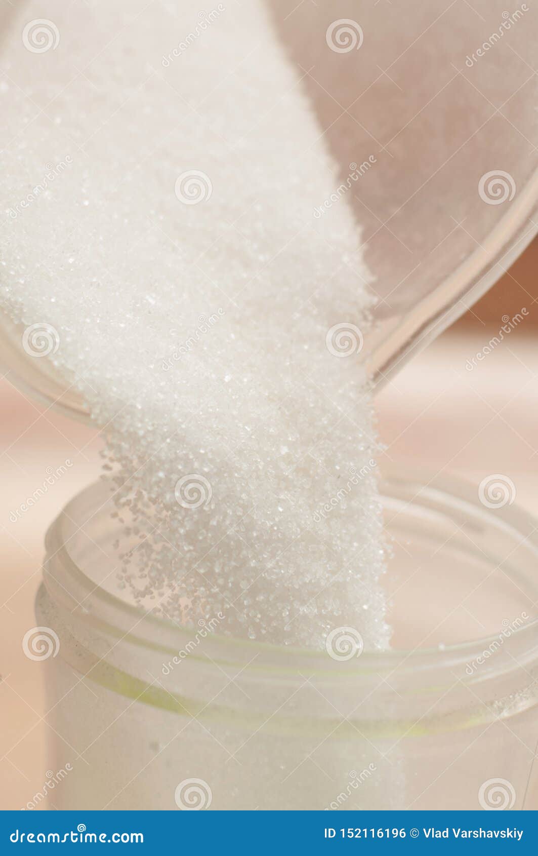 Pouring White Sugar into a Smaller Container for Ease of Use Stock ...