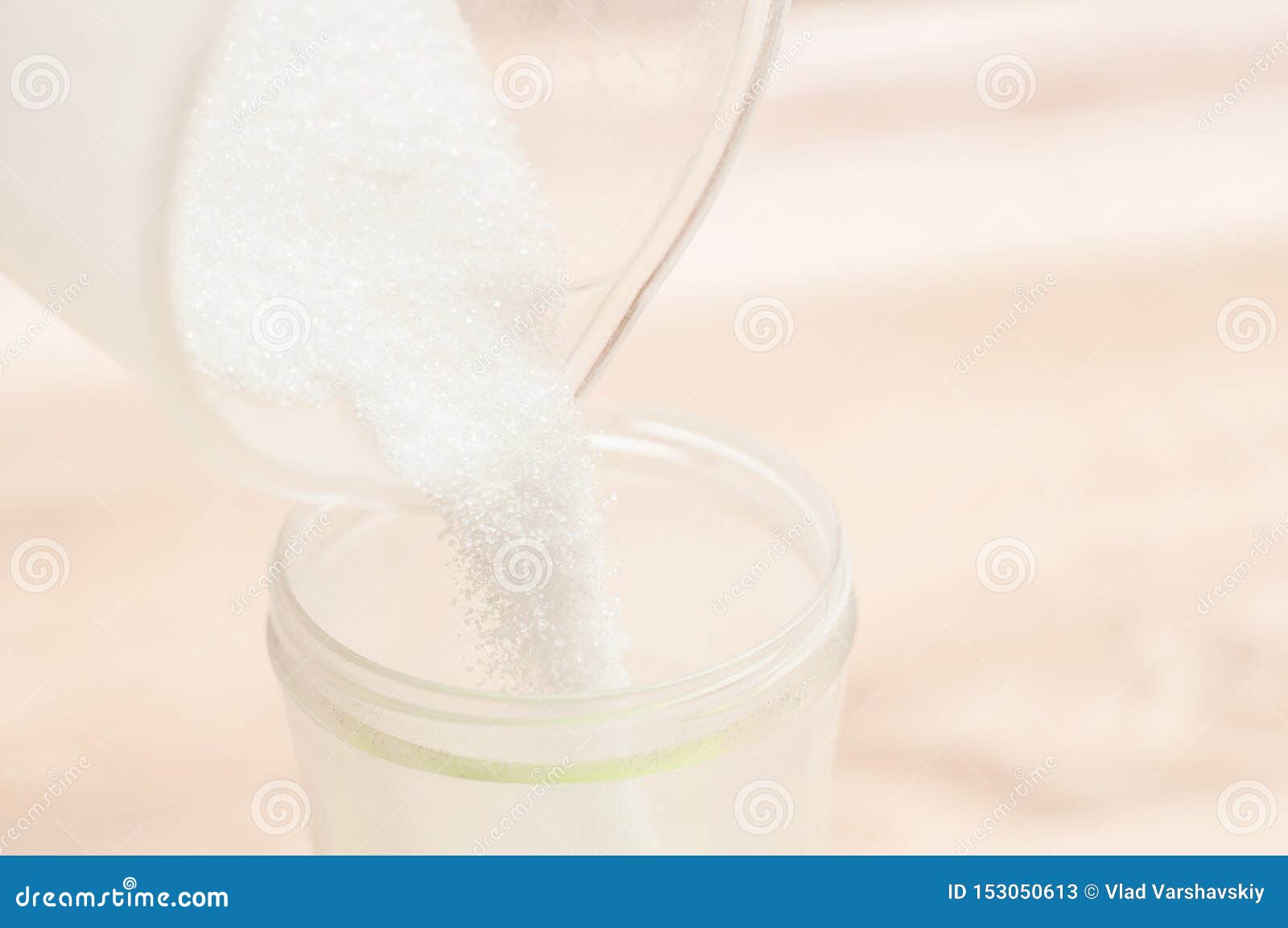 Pouring White Sugar into a Smaller Container for Ease of Use Stock ...