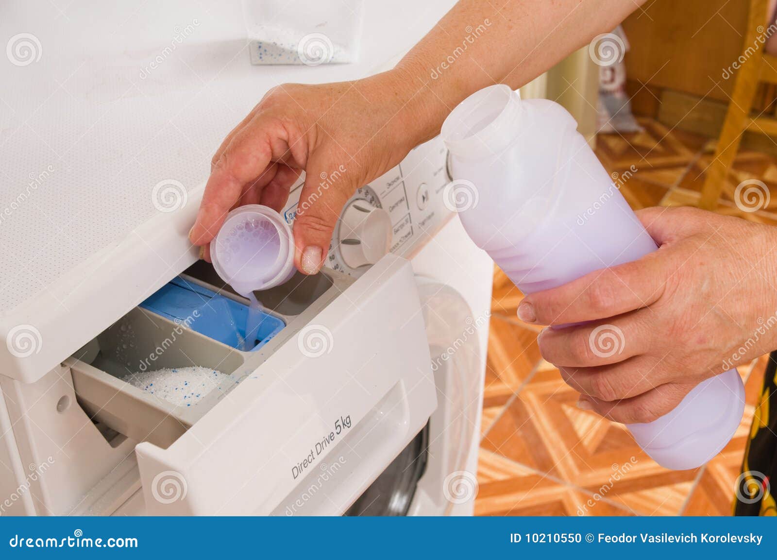 Pours a Washing Liquid in a Washing Machine. Stock Photo - Image of ...