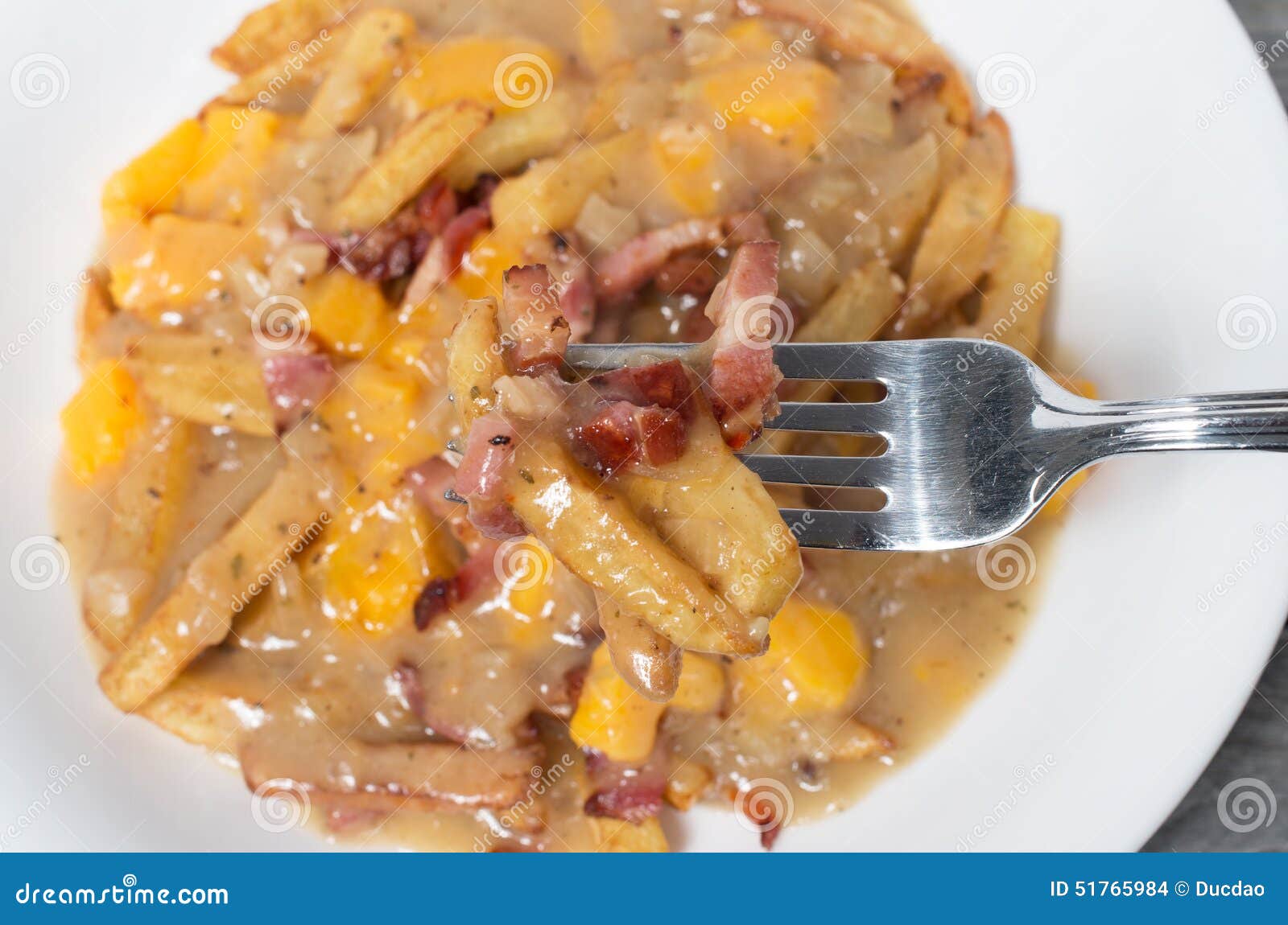 Poutine with Yellow Cheddar Cheese Stock Photo - Image of meal, sauce ...