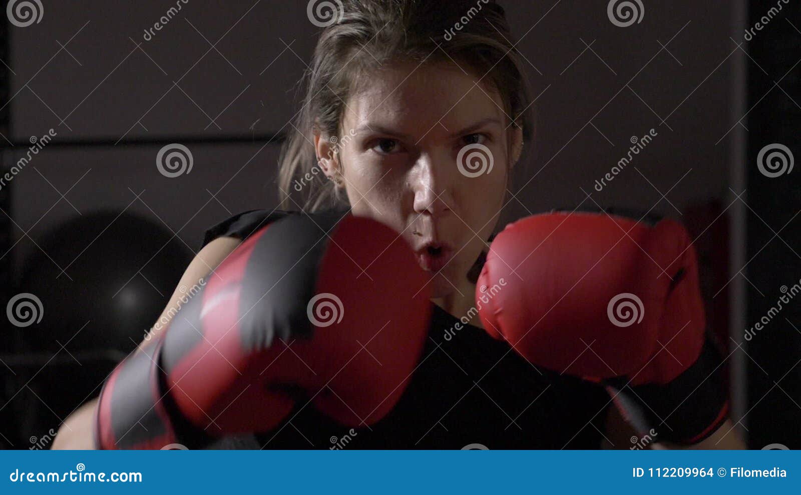 Pov Close Up Of Beautiful Female Model Looking Into The Camera And Shadow Boxing In Slow Motion