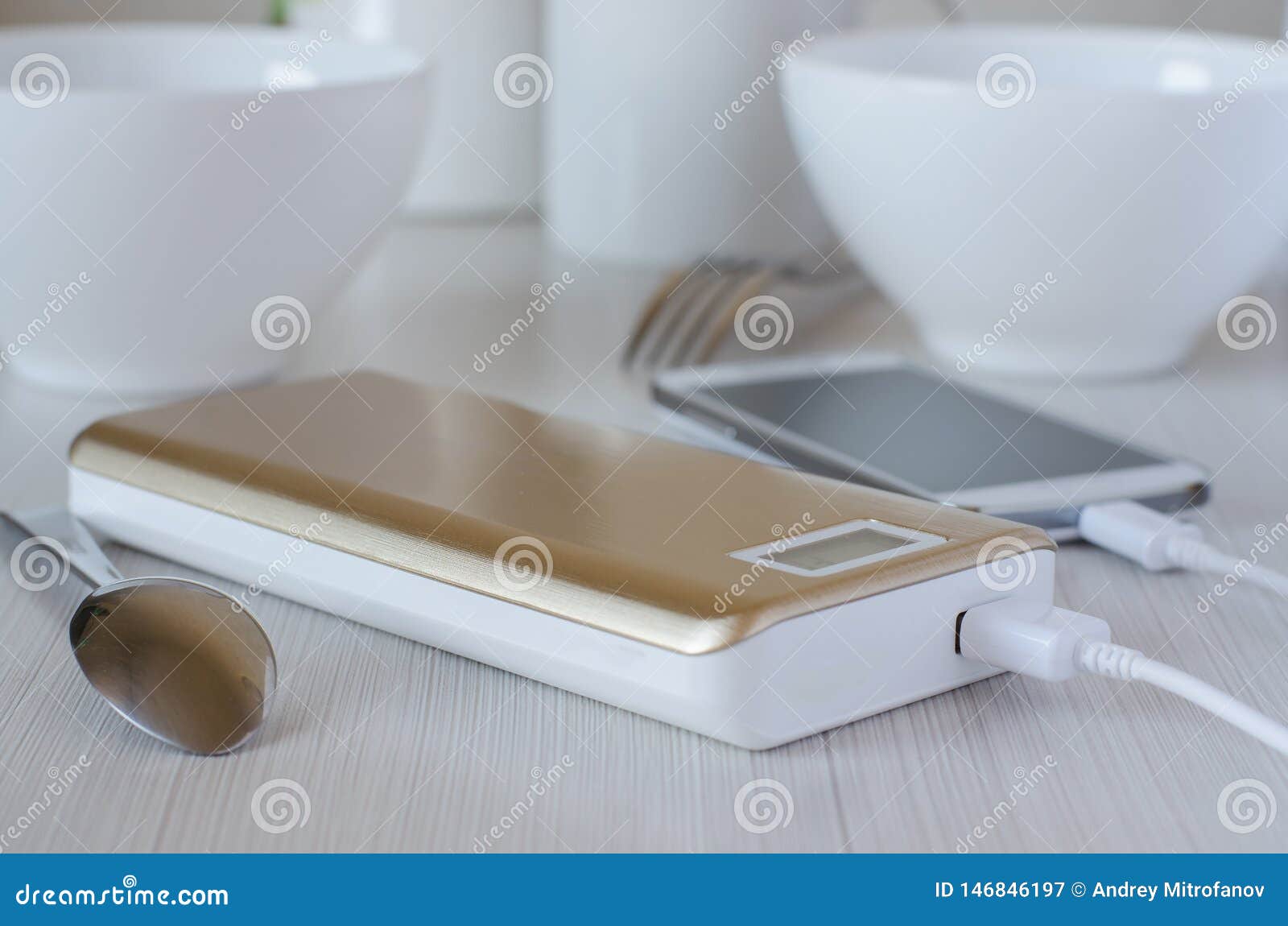 Power Bank Charges Cell Phone on the Kitchen Table Stock Image - Image ...