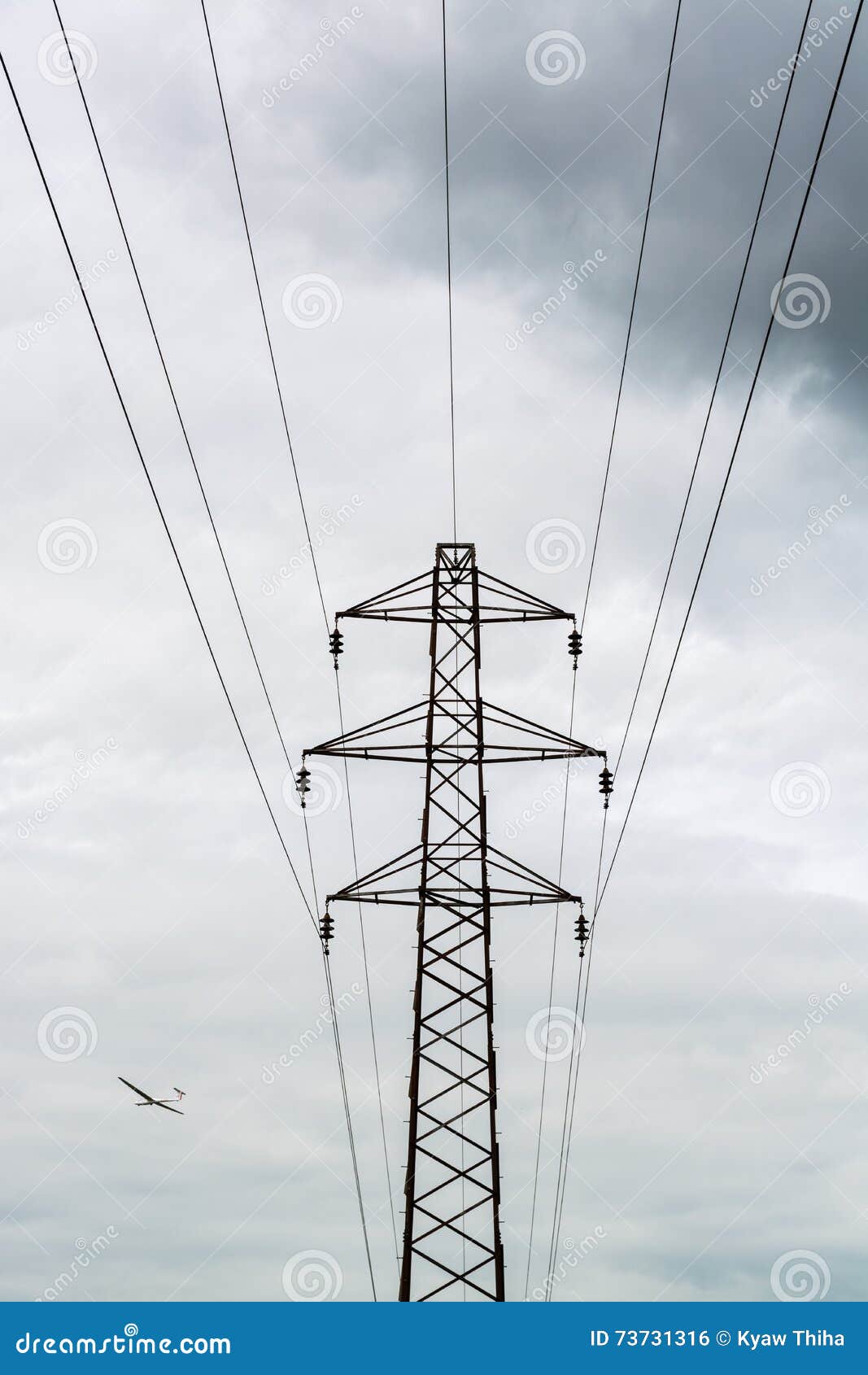 Power Cable Tower and a Small Plane on Overcast Day Stock Photo - Image ...