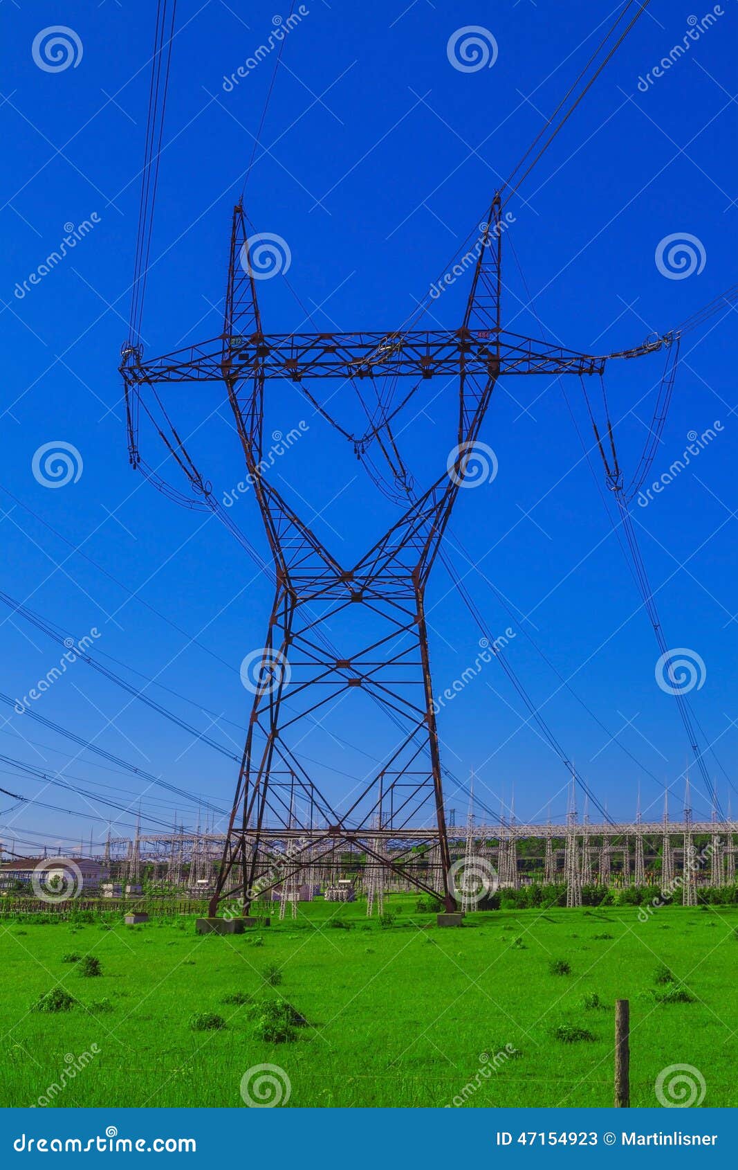 Power Line in the Middle of a Green Field with Blue Sky Stock Image ...