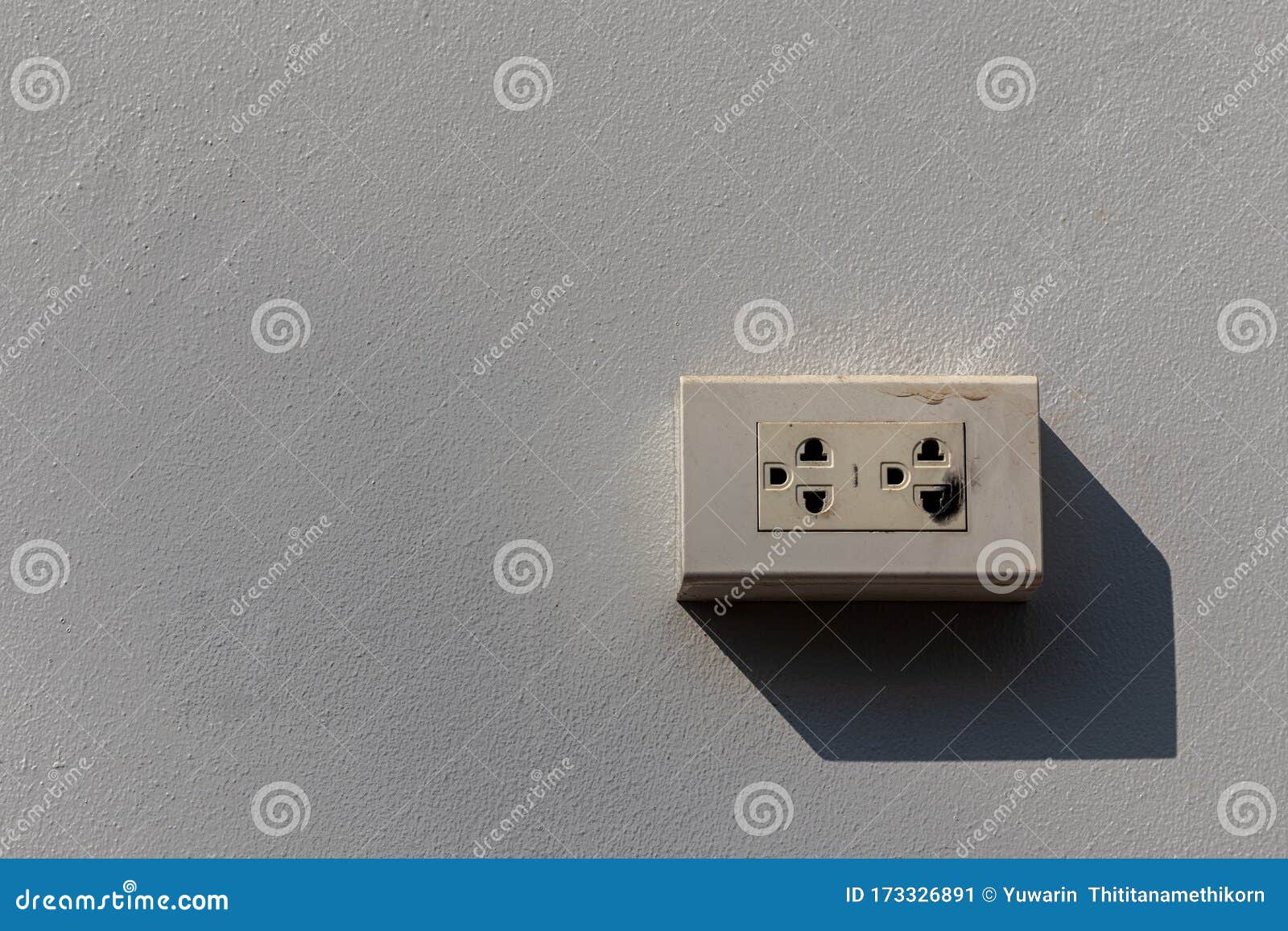 The Power Plug is Damaged by a Short Circuit on a White Concrete Wall ...
