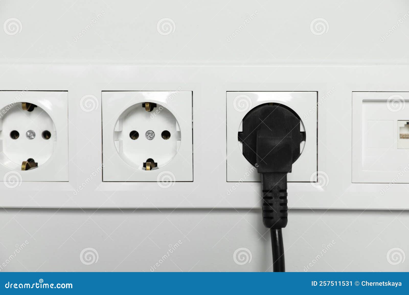 Power Sockets with Inserted Plug on White Wall, Closeup. Electrical ...