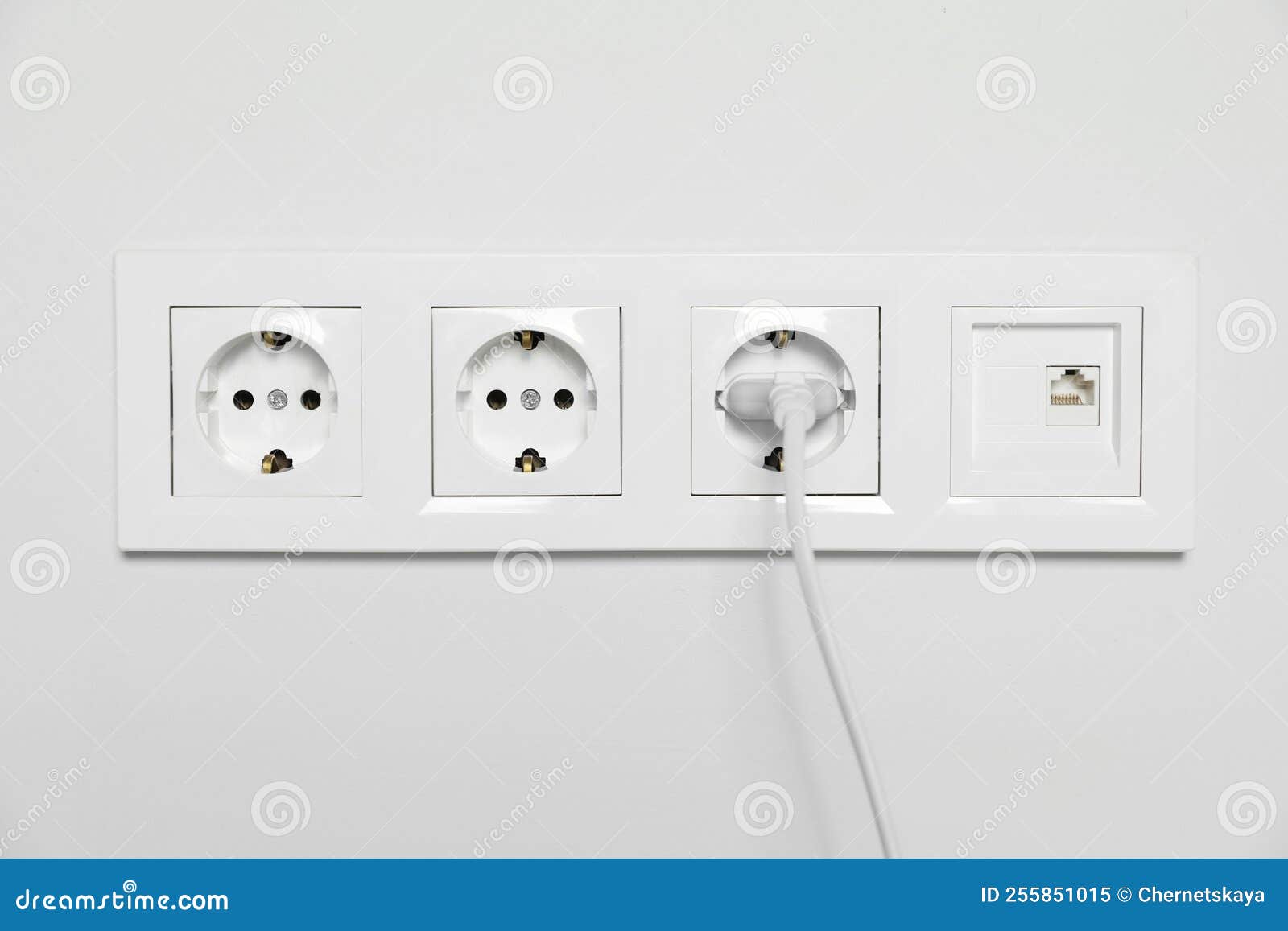 Power Sockets with Inserted Plug on White Wall. Electrical Supply Stock ...
