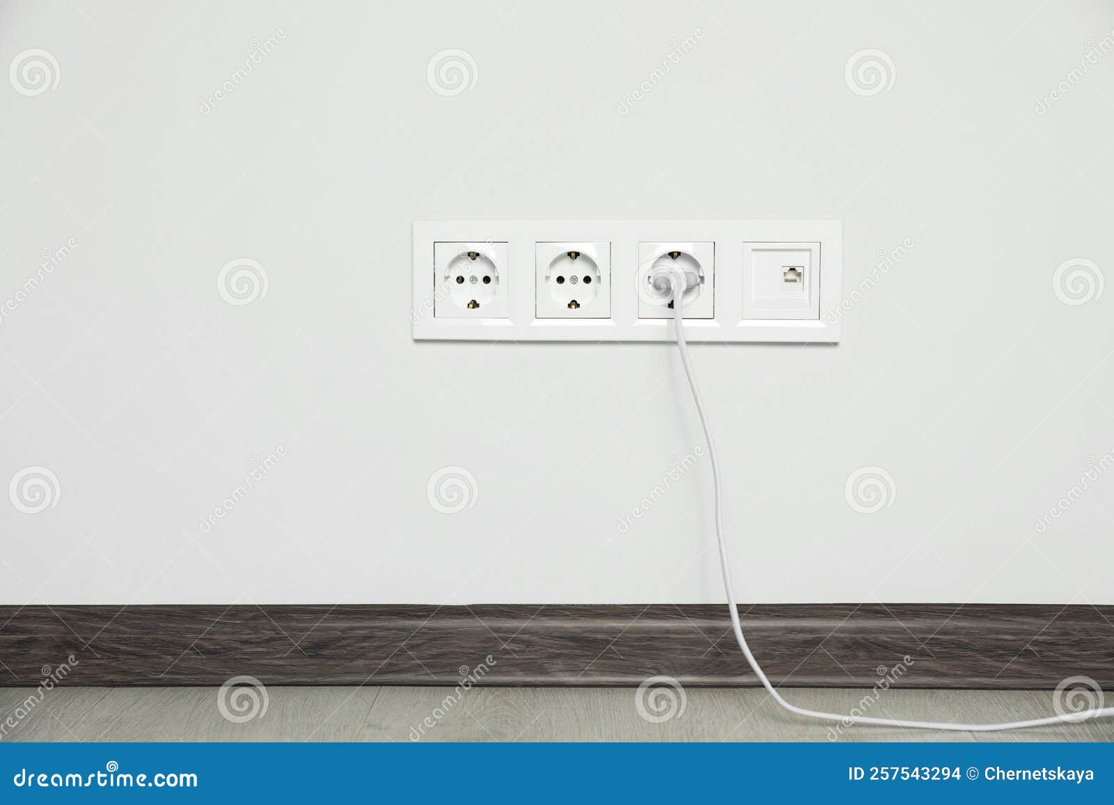 Power Sockets with Inserted Plug on White Wall Indoors. Electrical ...