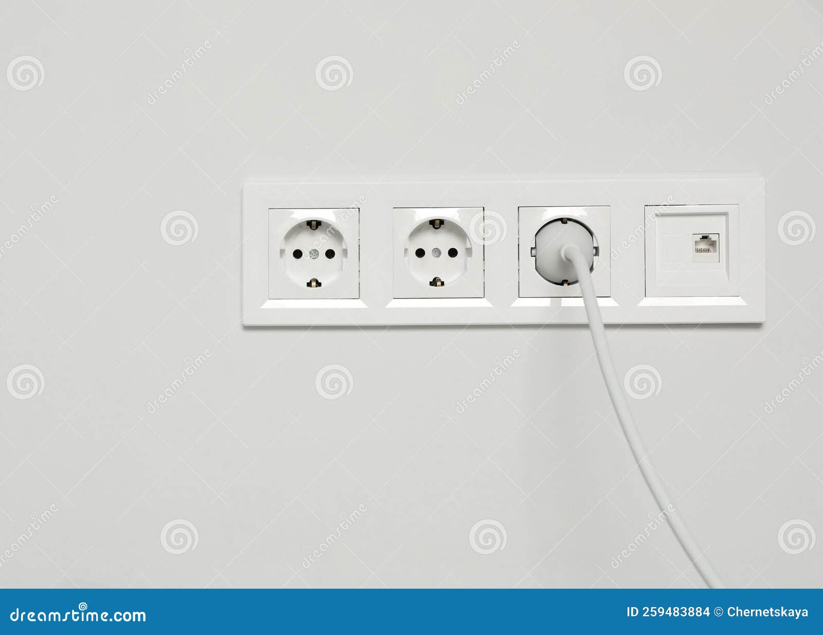 Power Sockets with Inserted Plug on White Wall Indoors. Electrical ...