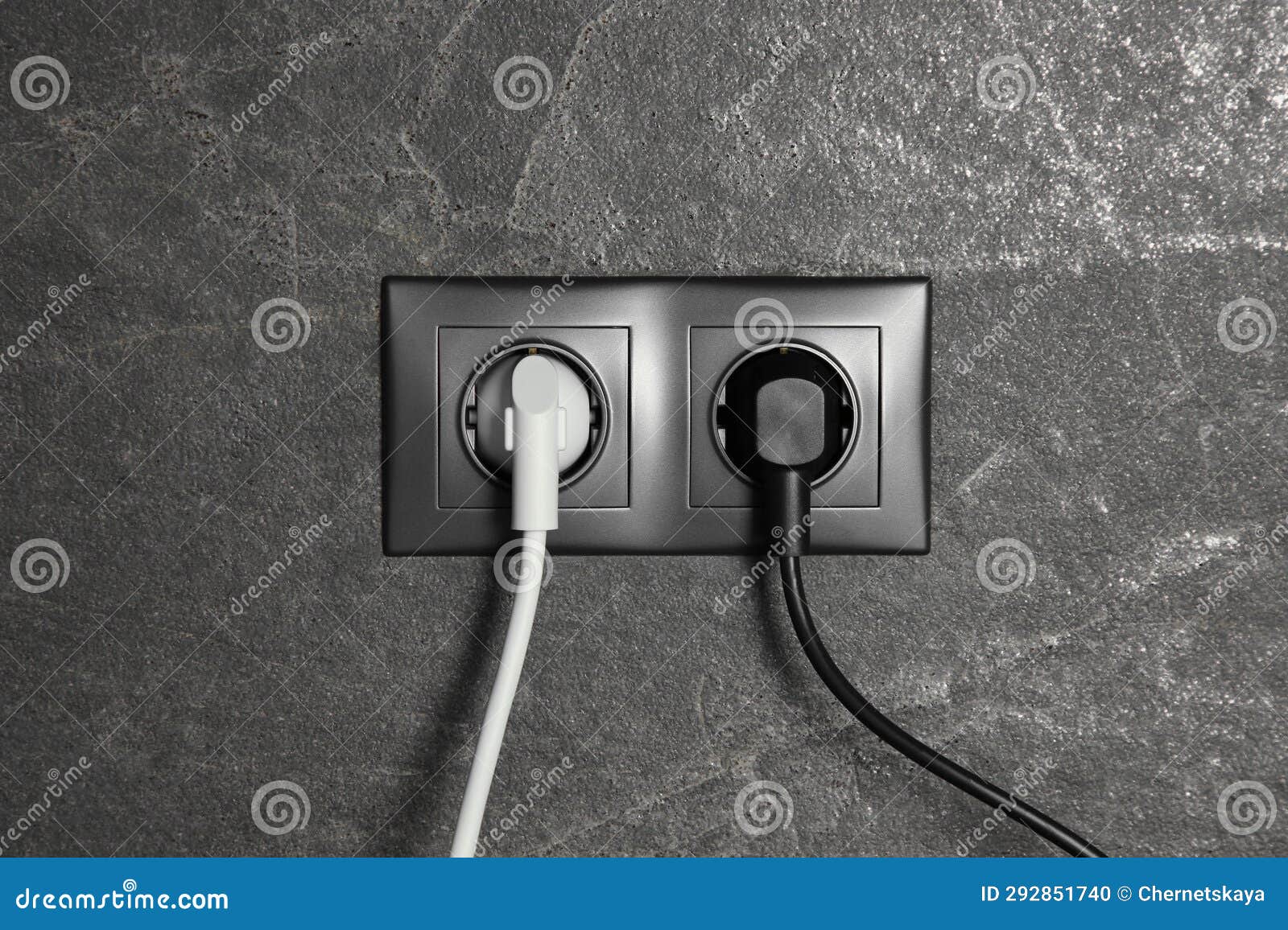 Power Sockets with Inserted Plugs on Dark Grey Wall. Electrical Supply ...