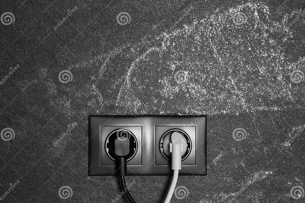 Power Sockets with Inserted Plugs on Dark Grey Wall, Space for Text ...