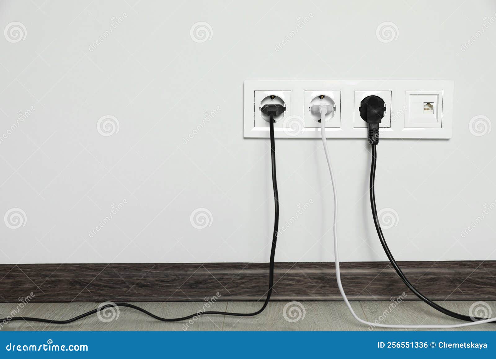 Power Sockets with Inserted Plugs on White Wall Indoors, Space for Text ...