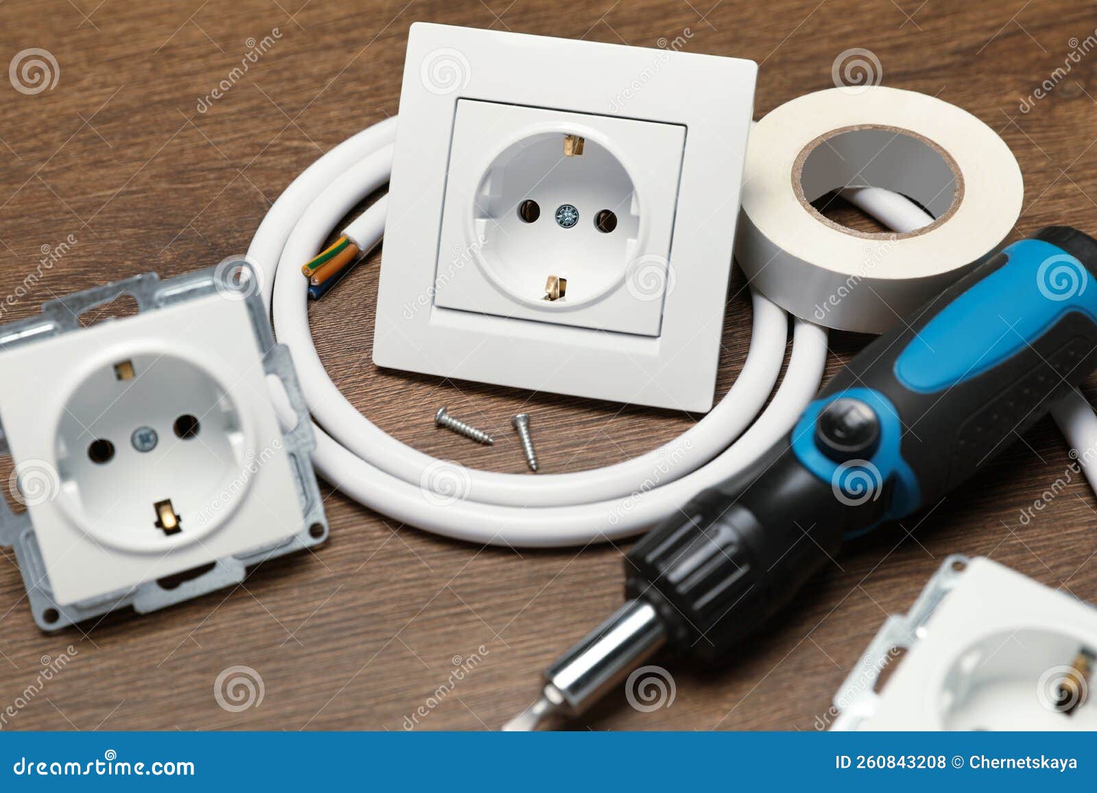 Power Sockets, Screwdriver, Cable and Insulating Tape on Wooden Table ...