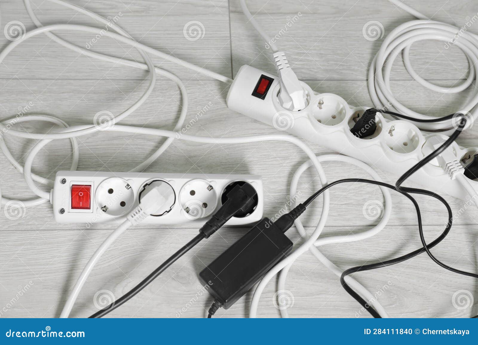 Power Strips with Different Electrical Plugs on White Floor, Flat Lay ...