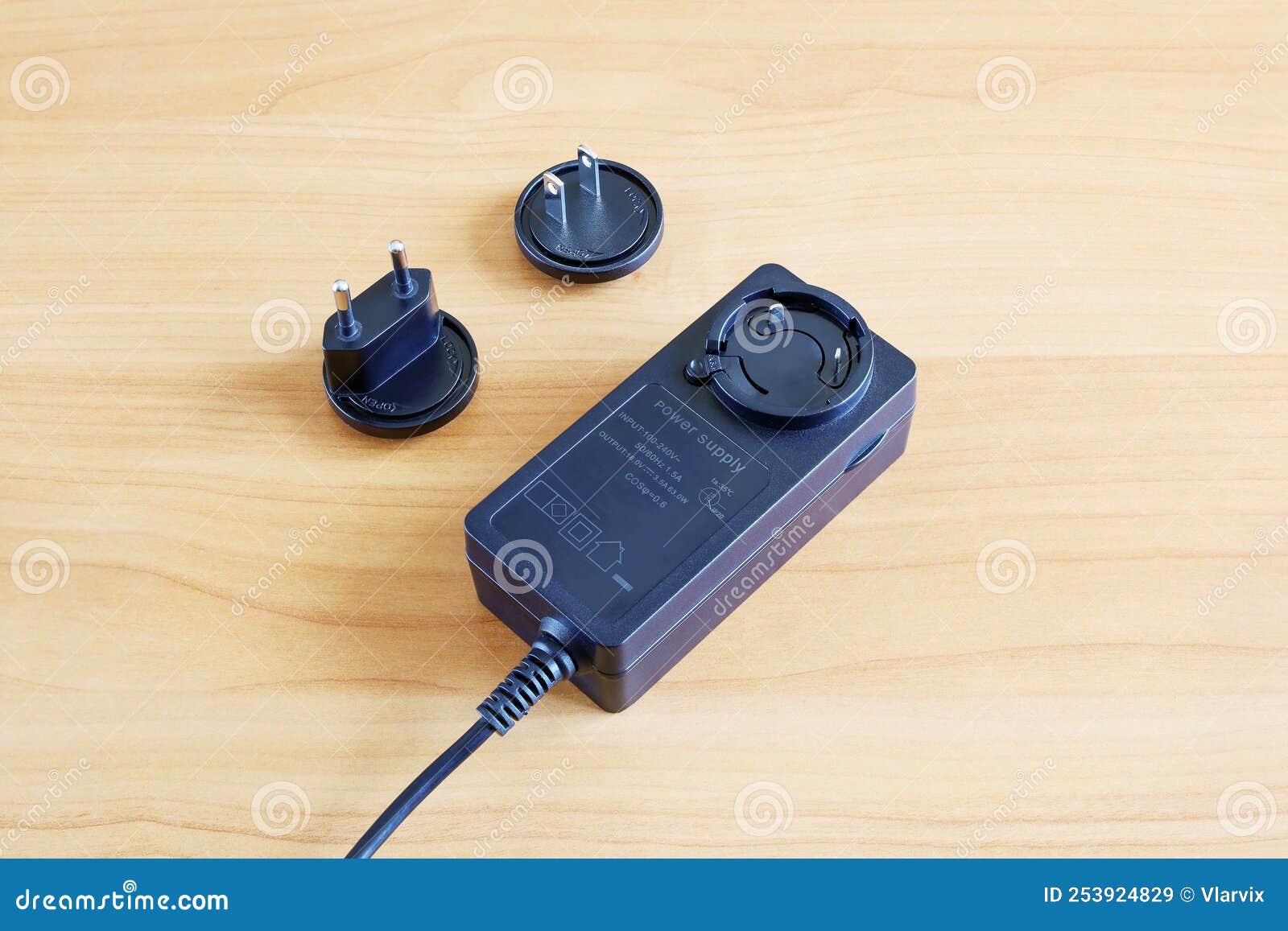 Power Supply Adapter Lies on Wooden Surface with Connecting Variations ...