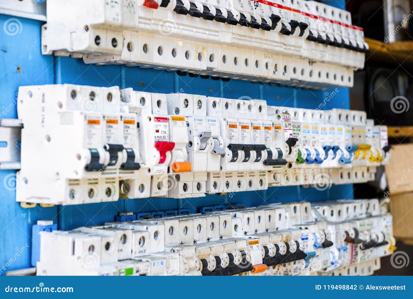 A Man Switches The Toggle Switches Of The Electrical Panel On The Pole ...