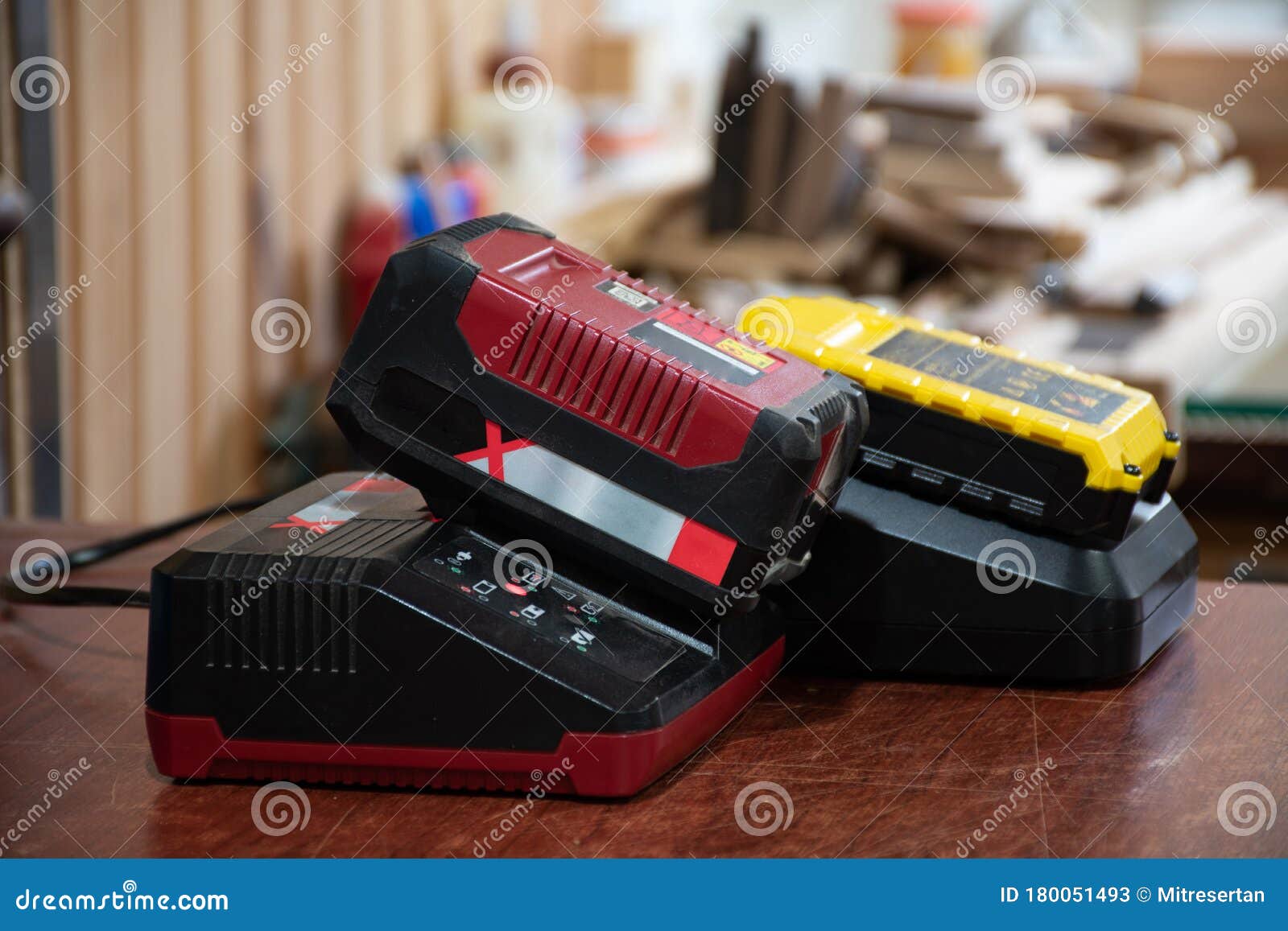 Power Tools Lithium-ion Batteries on Charge for Hand Tools on Workbench ...