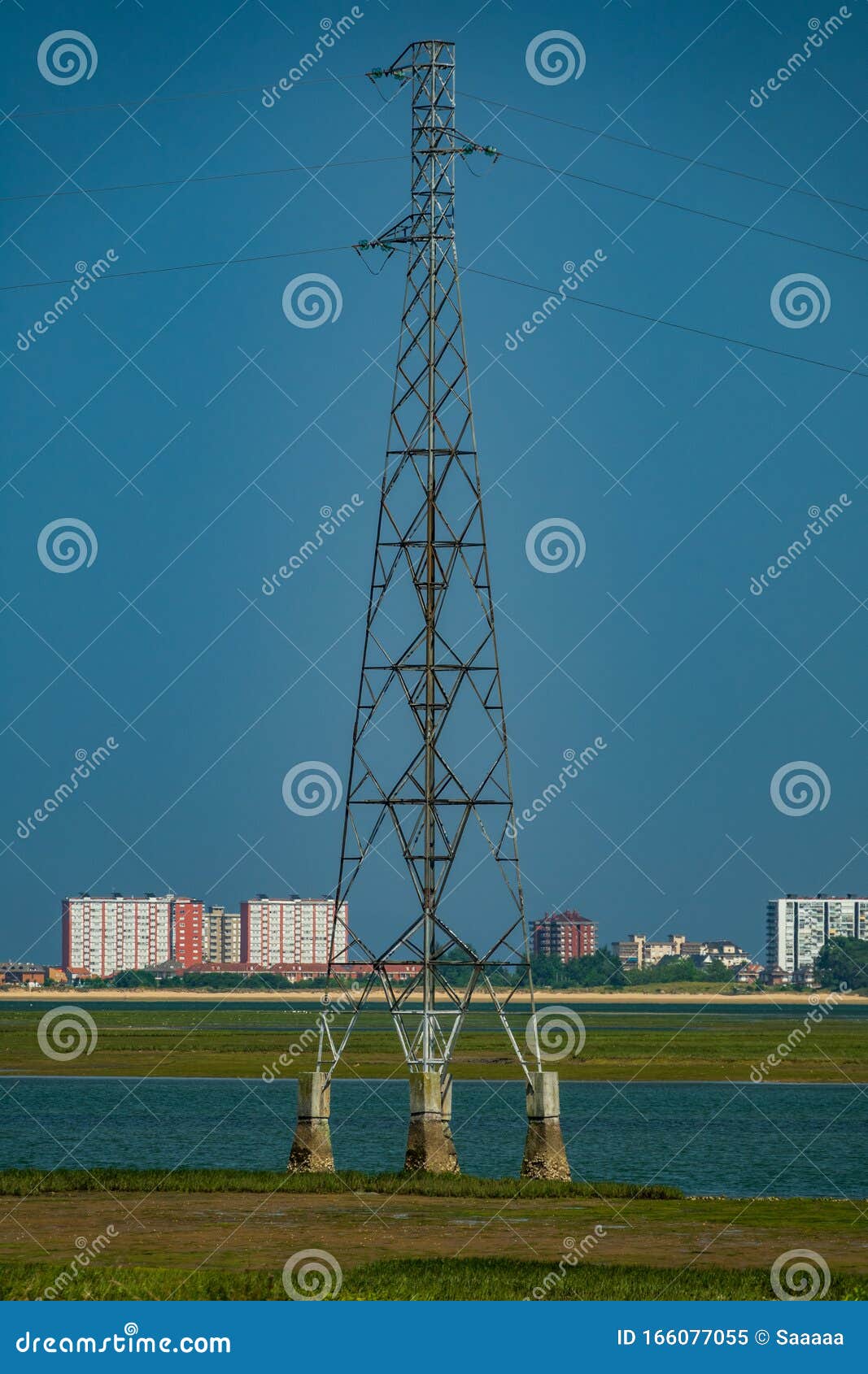Power Tower Over the Marsh with Buildings in the Background Stock Image ...