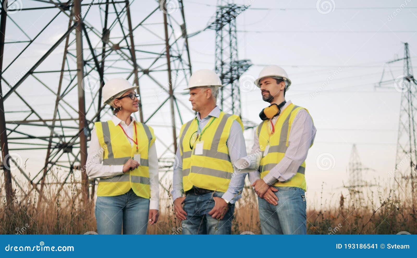 Power Workers are Talking about Plans in the Field with Electrical ...