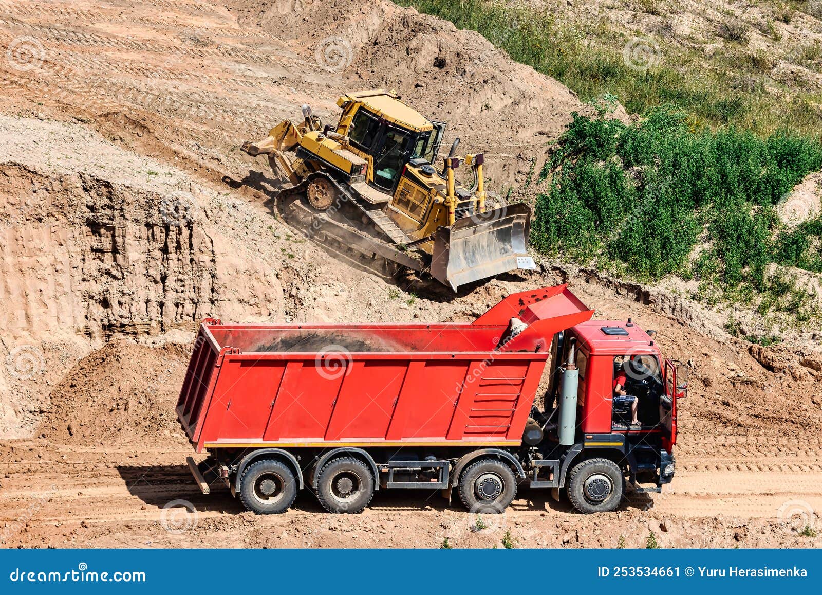 A Powerful Bulldozer in a Sand Pit is Planning a Site. Extraction of ...