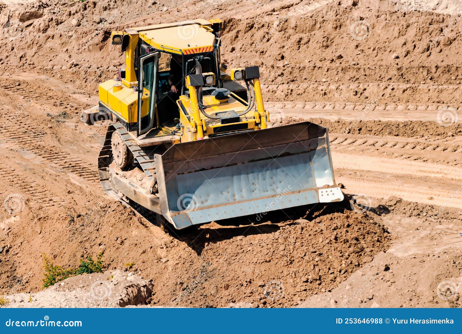 A Powerful Bulldozer in a Sand Pit is Planning a Site. Extraction of ...