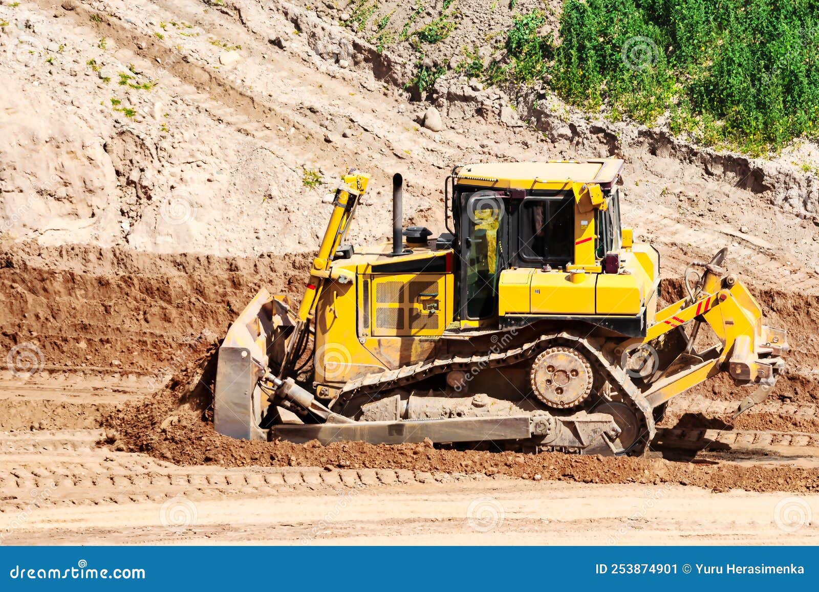 A Powerful Bulldozer in a Sand Pit is Planning a Site. Extraction of ...
