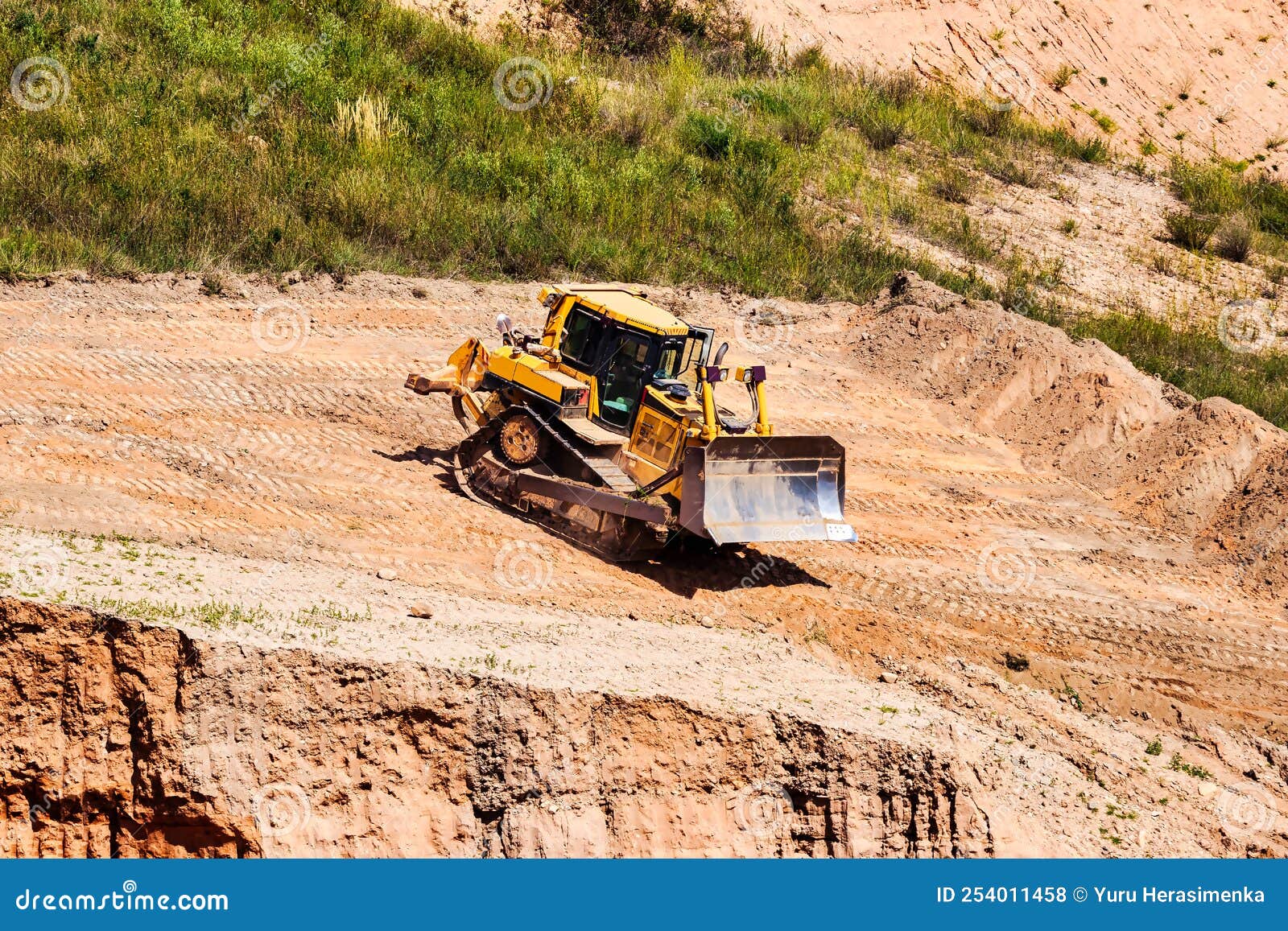 A Powerful Bulldozer in a Sand Pit is Planning a Site. Extraction of ...