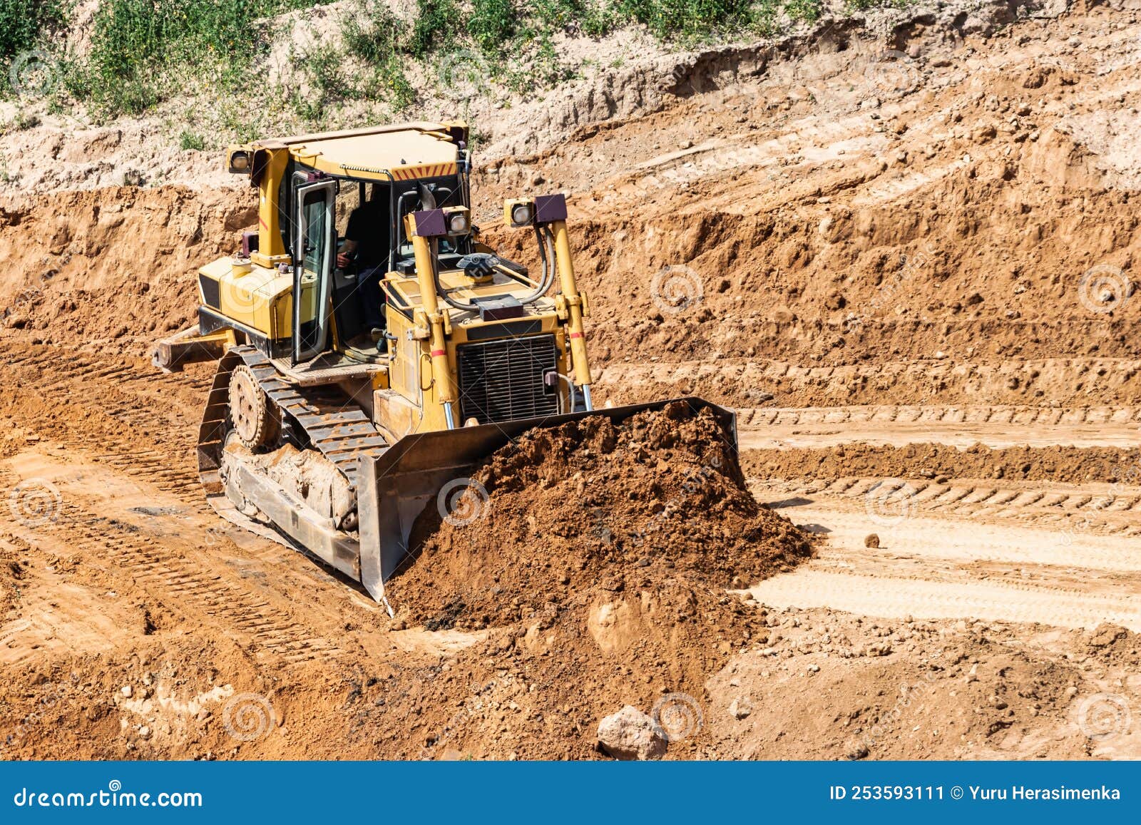 A Powerful Bulldozer in a Sand Pit is Planning a Site. Extraction of ...