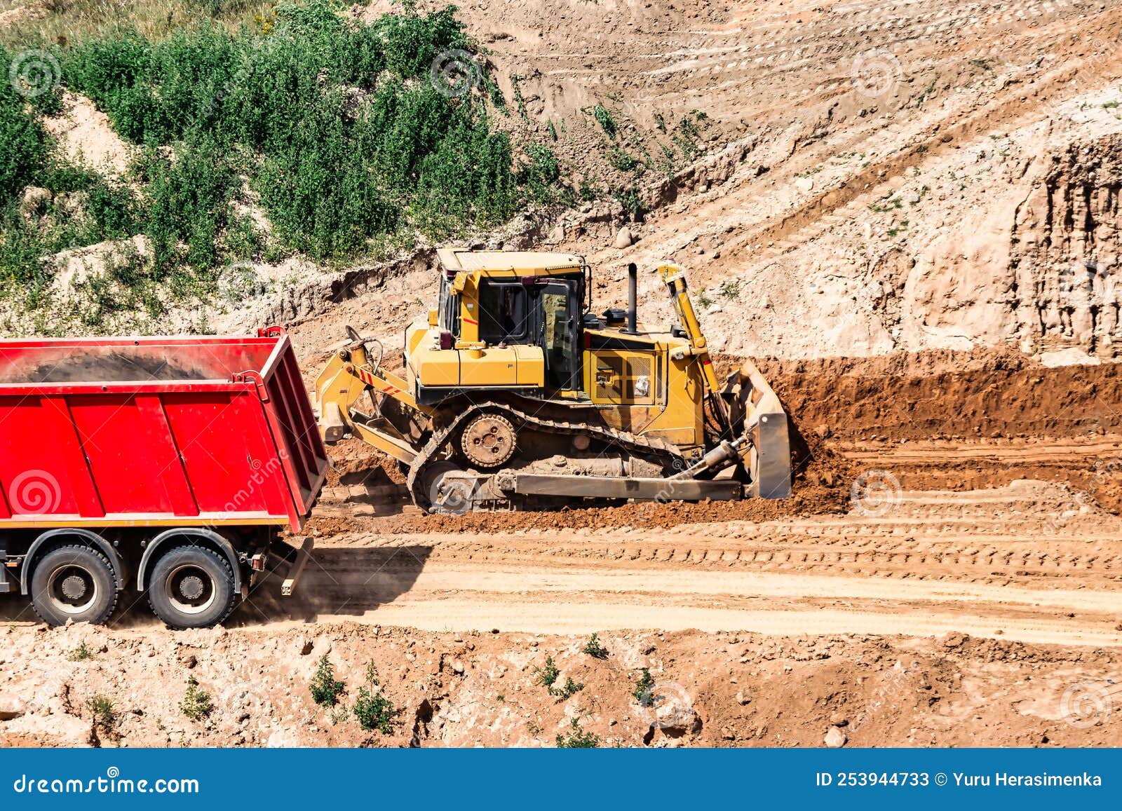 A Powerful Bulldozer in a Sand Pit is Planning a Site. Extraction of ...