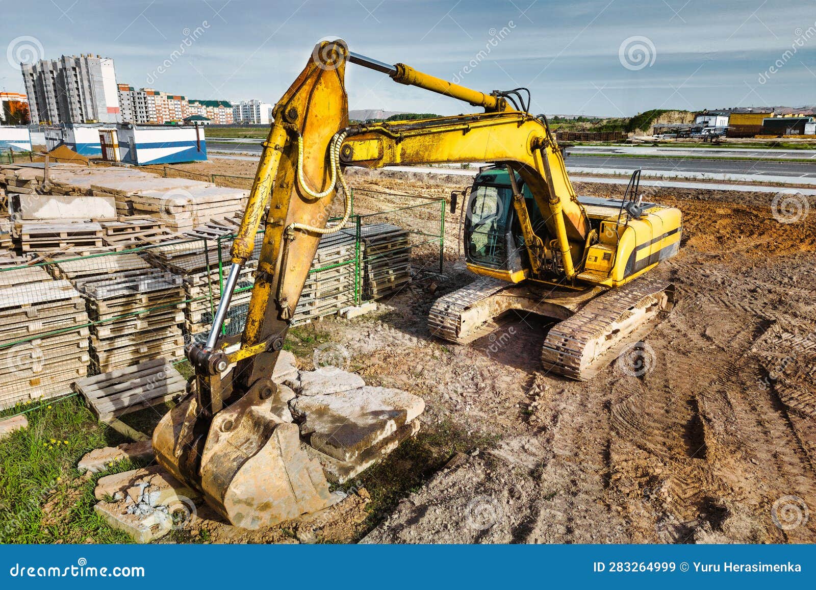 A Powerful Crawler Excavator is Working on a Construction Site. Close ...
