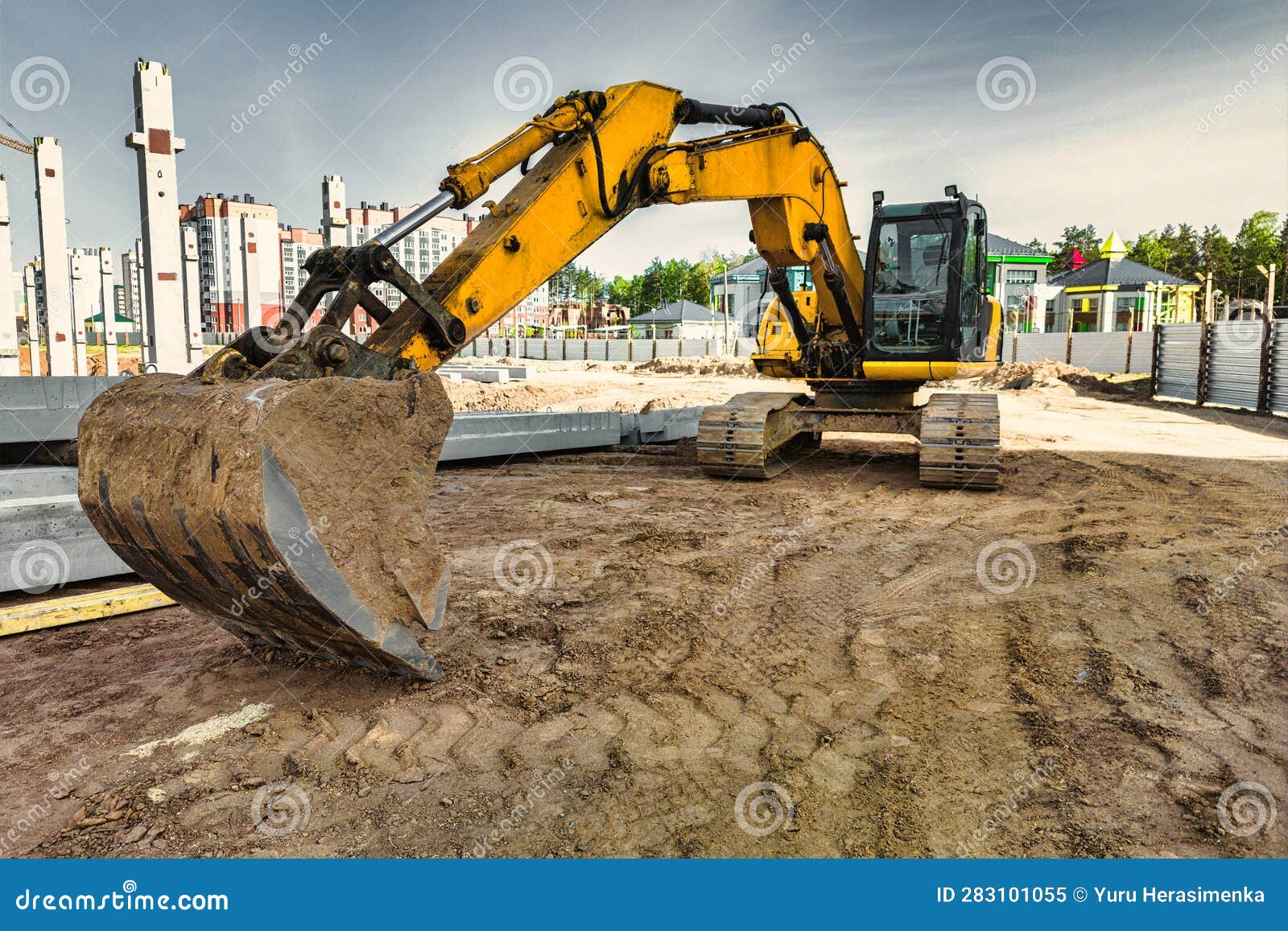 A Powerful Crawler Excavator is Working on a Construction Site. Close ...