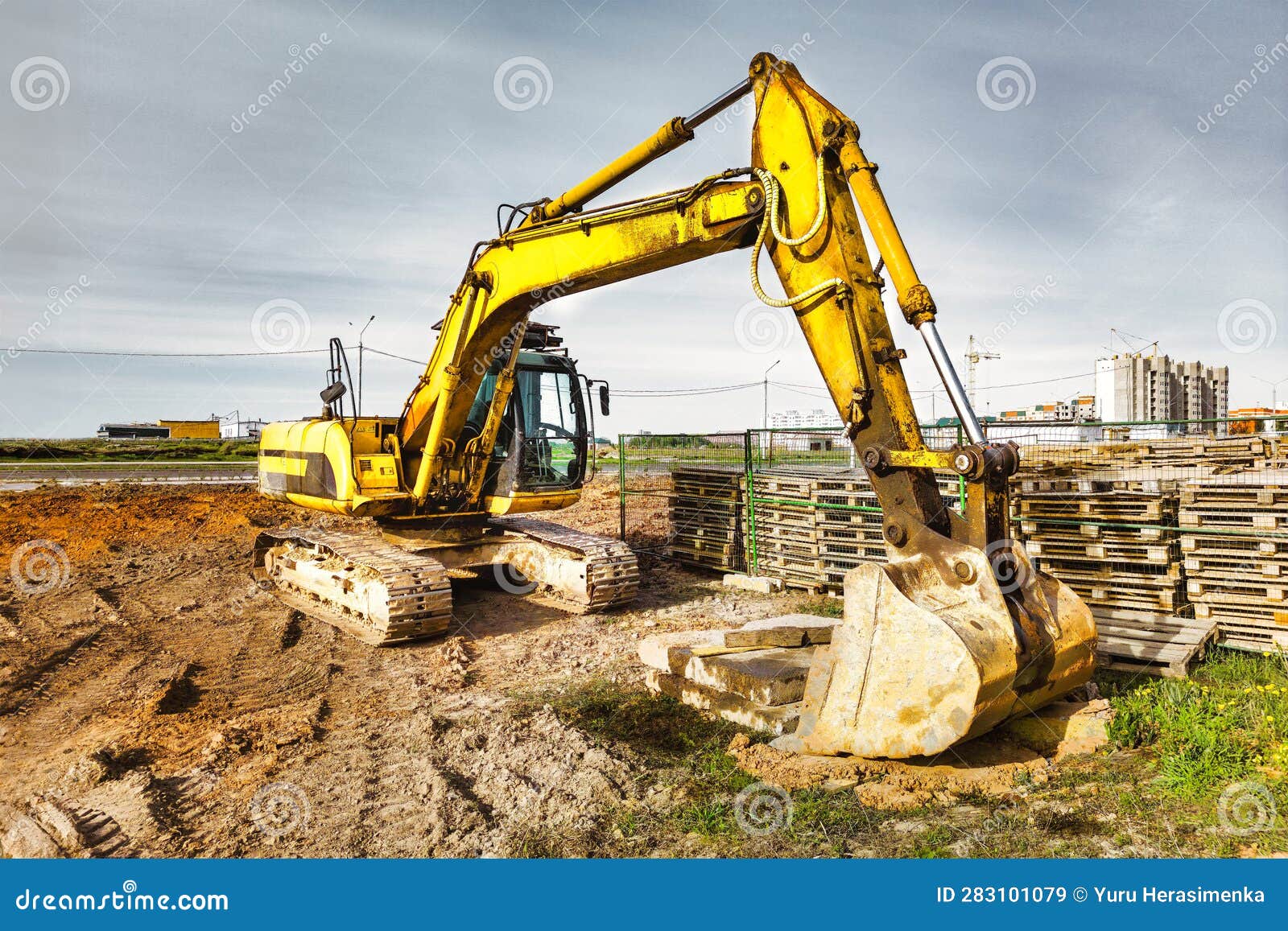 A Powerful Crawler Excavator is Working on a Construction Site. Close ...
