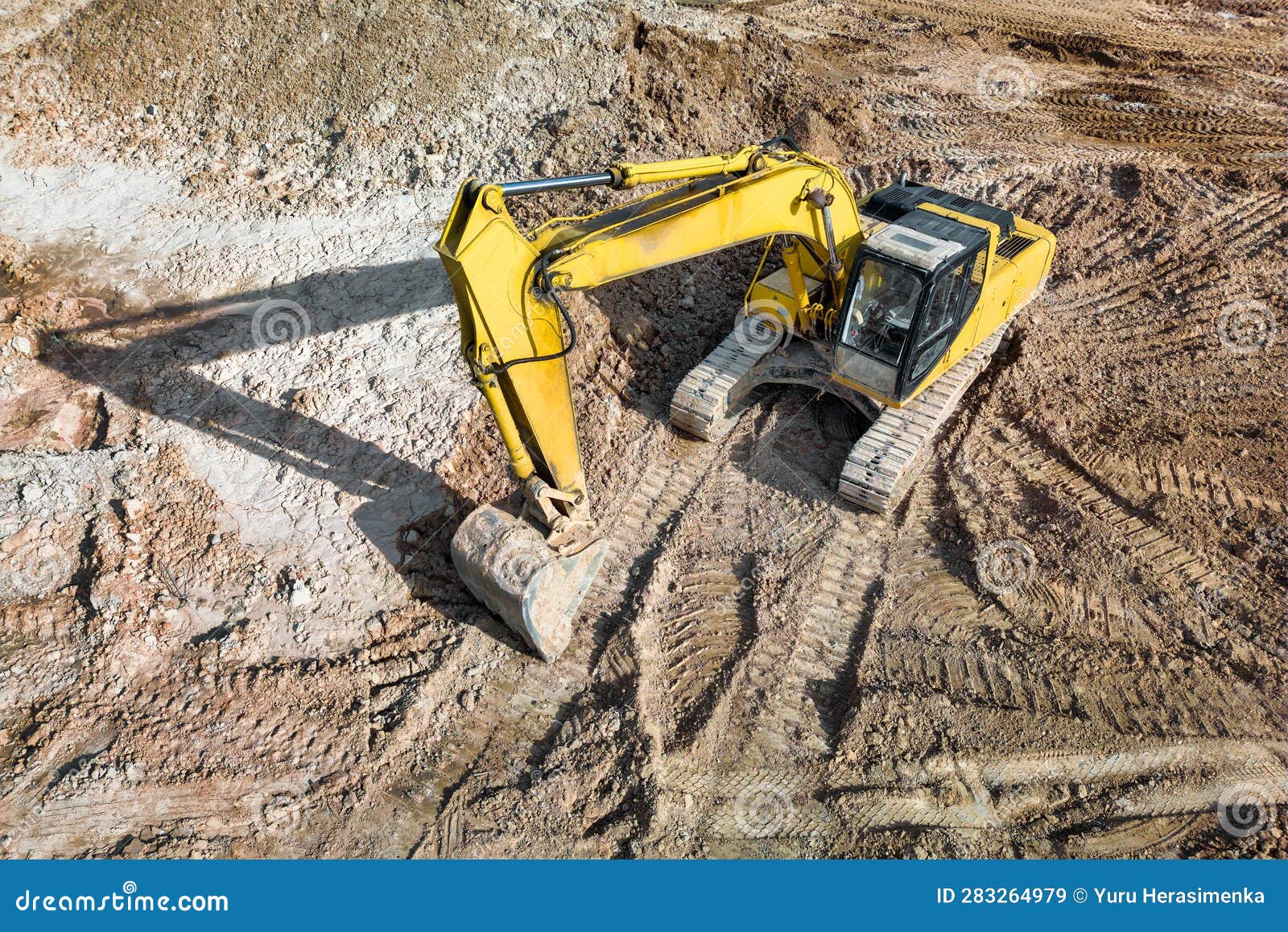 A Powerful Crawler Excavator is Working on a Construction Site. Close ...
