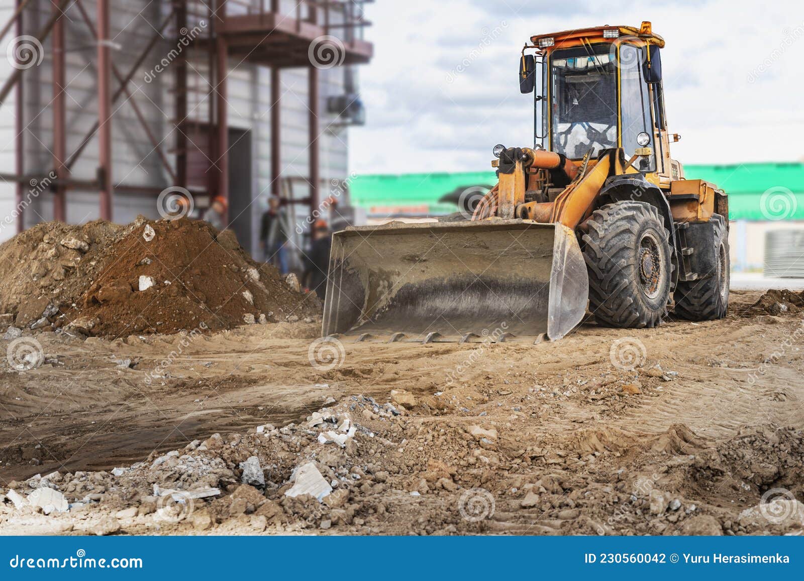 A Powerful Front Loader On A Construction Site Clears Up The Battle ...