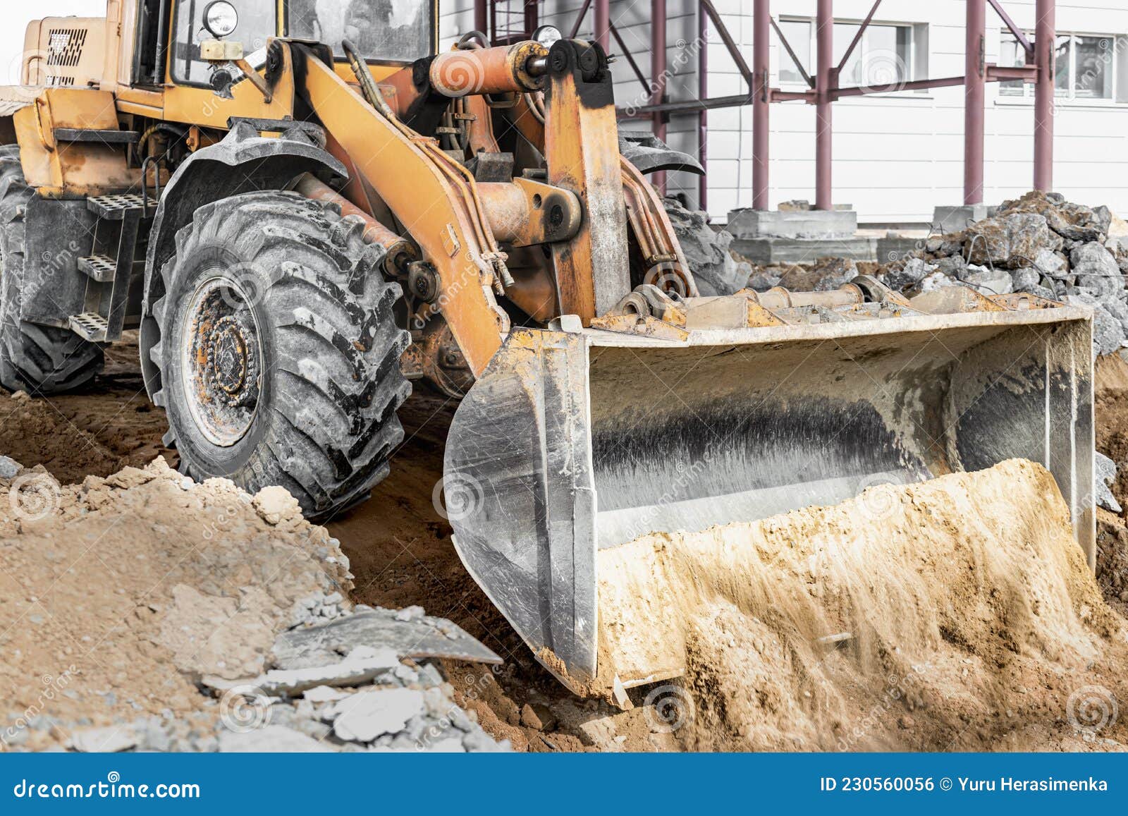 A Powerful Front Loader On A Construction Site Clears Up The Battle ...