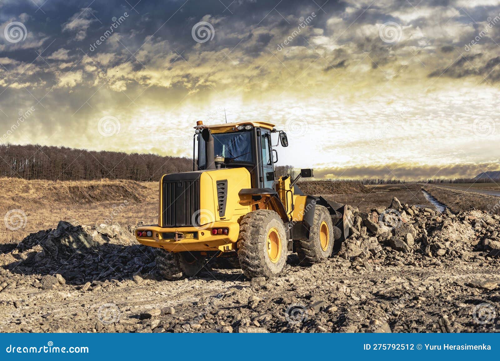 Powerful Front Wheel Loader or Bulldozer Working on a Quarry or ...