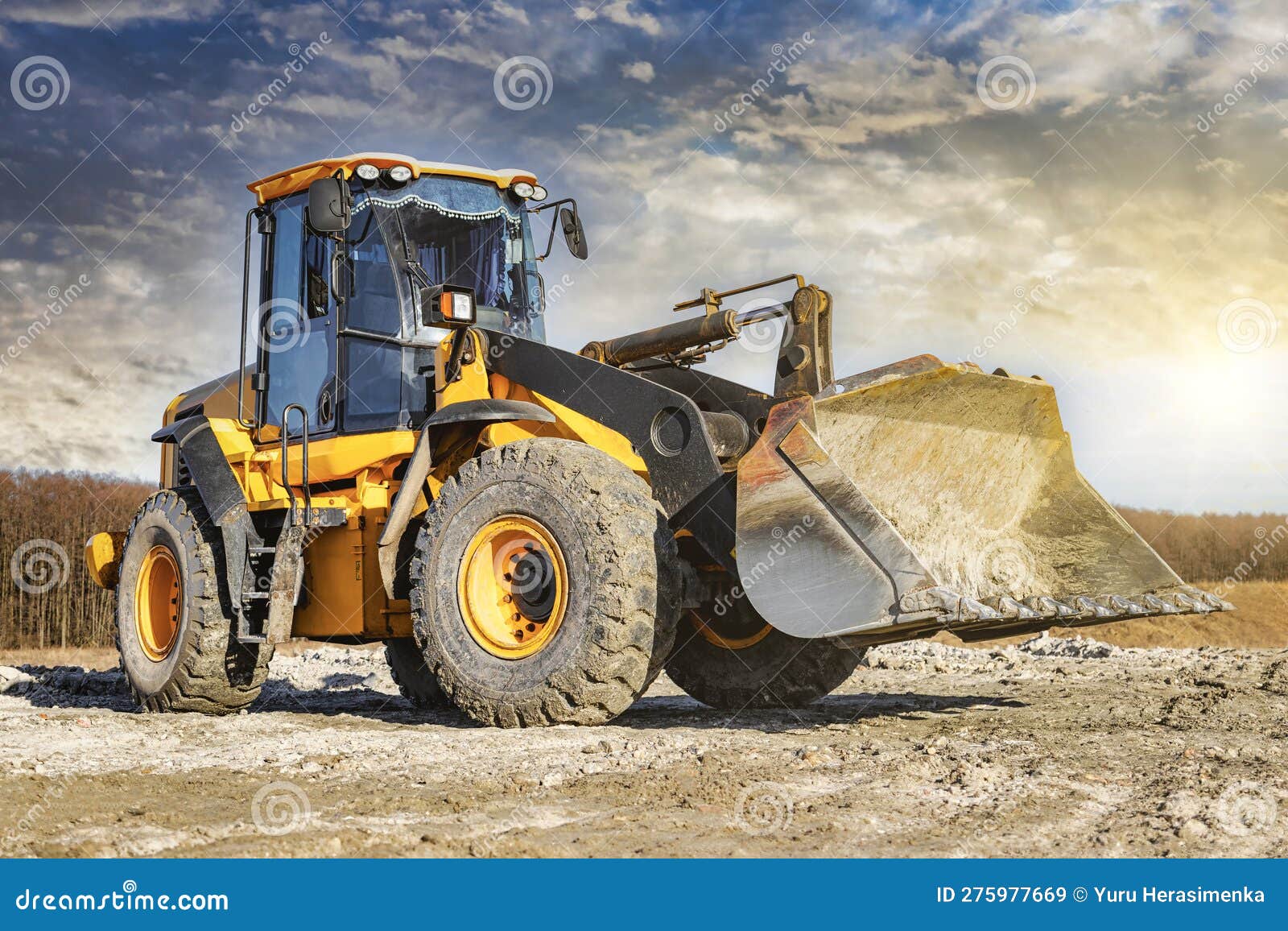 Powerful Front Wheel Loader or Bulldozer Working on a Quarry or ...