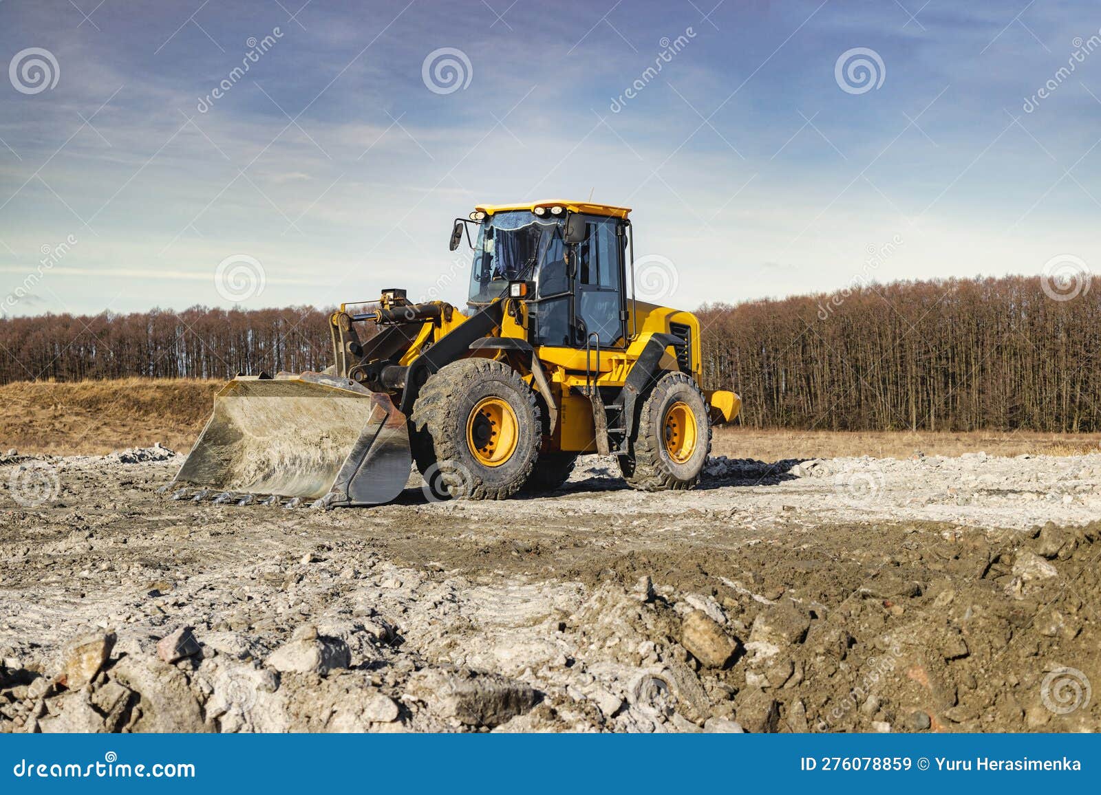 Powerful Front Wheel Loader or Bulldozer Working on a Quarry or ...